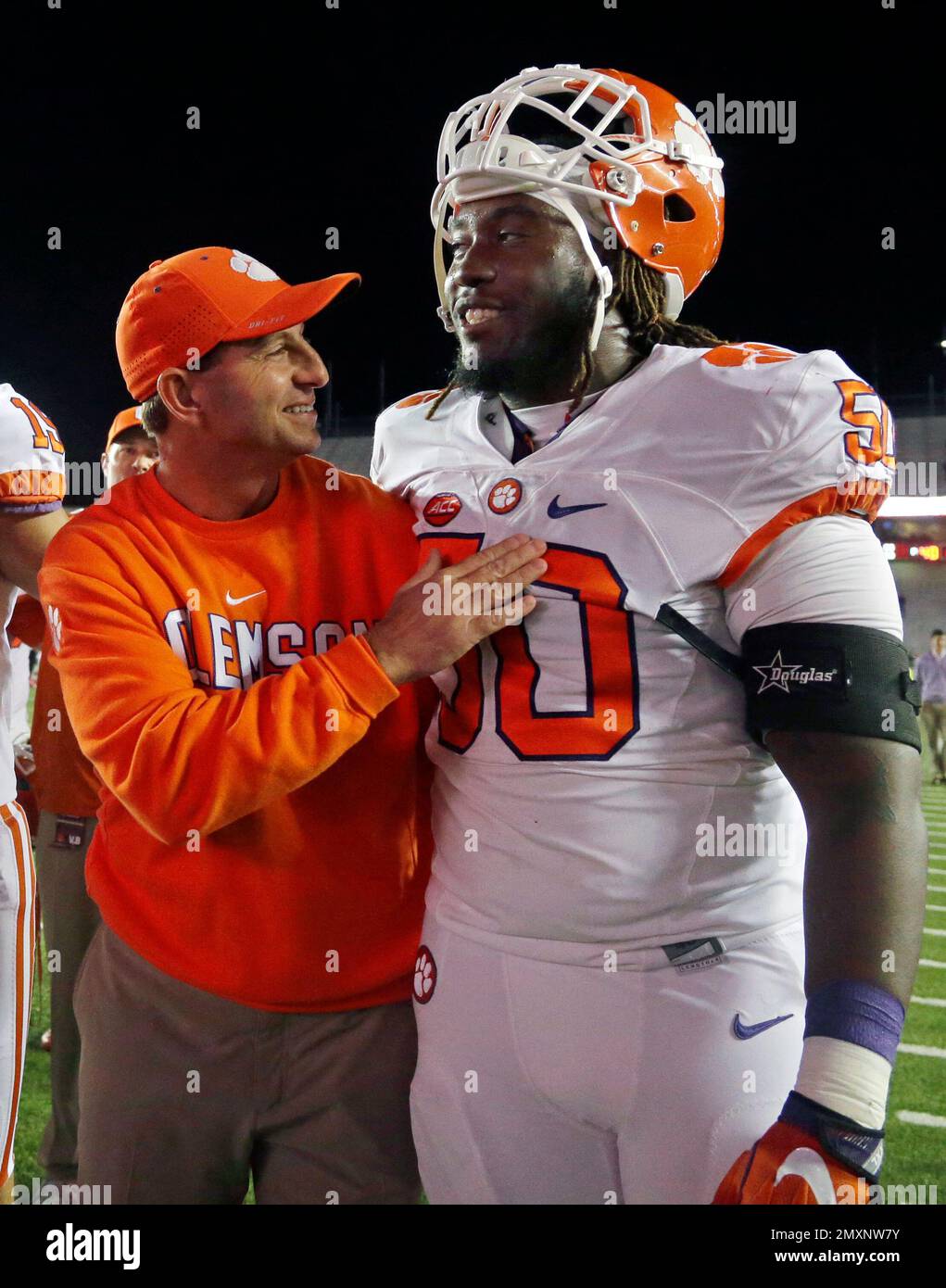 Clemson head coach Dabo Swinney celebrates with defensive lineman ...