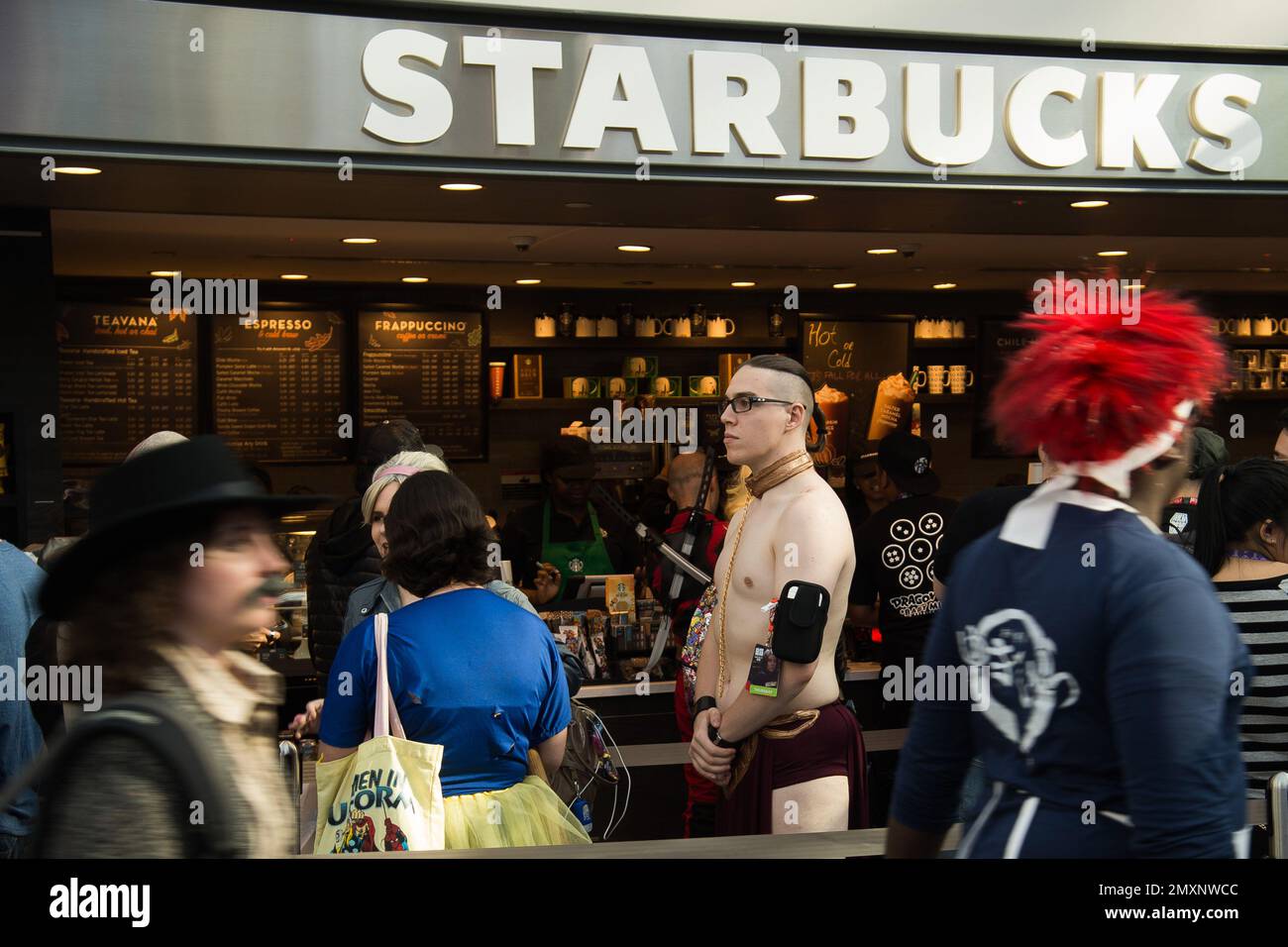 Costumed characters wait in line at Starbucks during New York Comic Con ...