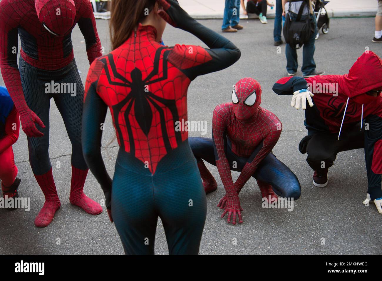 Attendees dressed as Spider-Man pose outside New York Comic Con at the ...