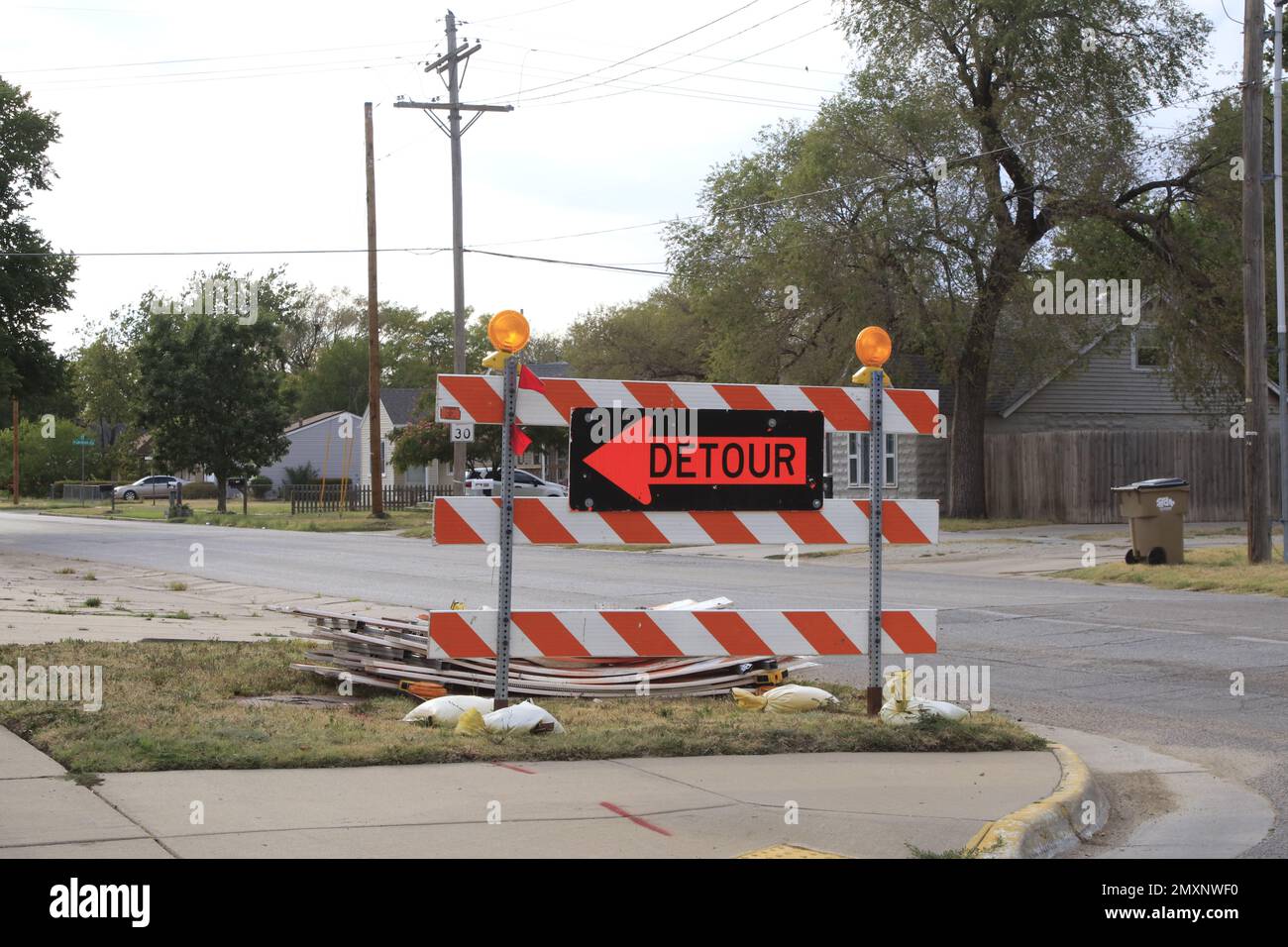 Detour Sign in a street for Road construction with sky and tree's Stock ...
