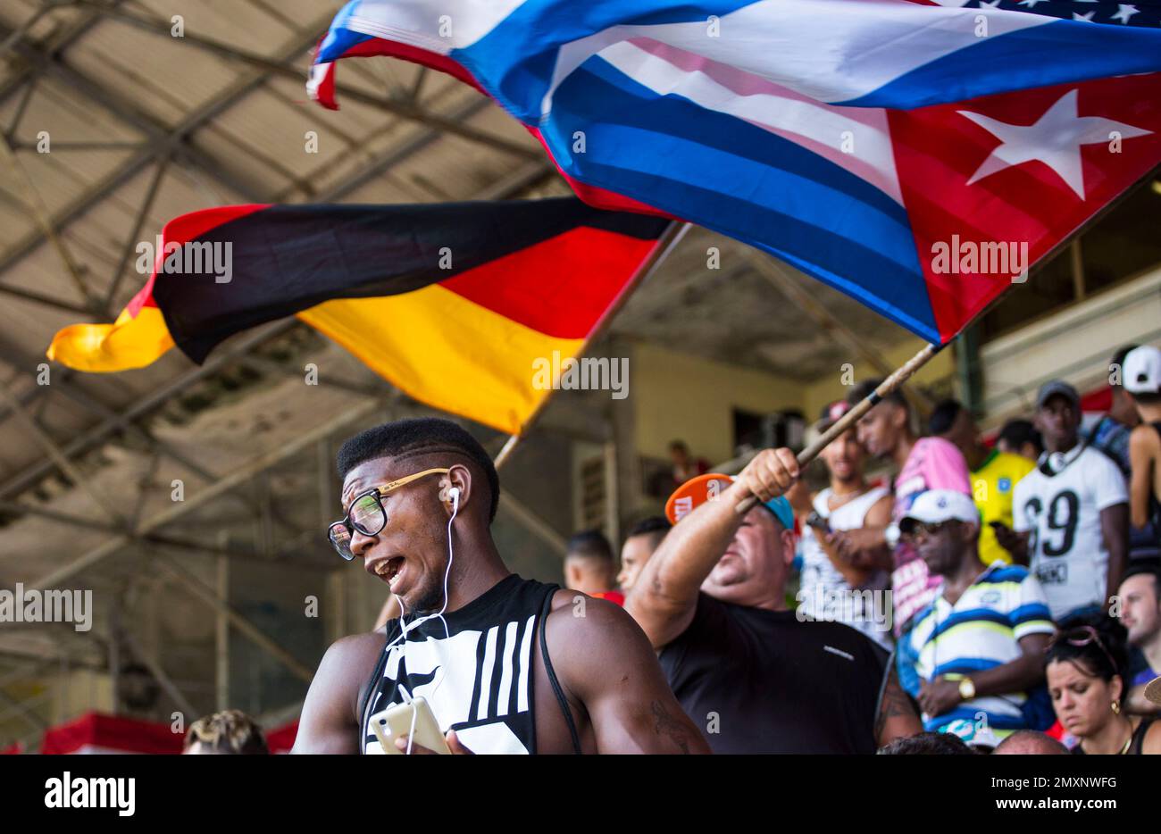 A fan waves a Cuban national flag in the stands of the Pedro Marrero ...