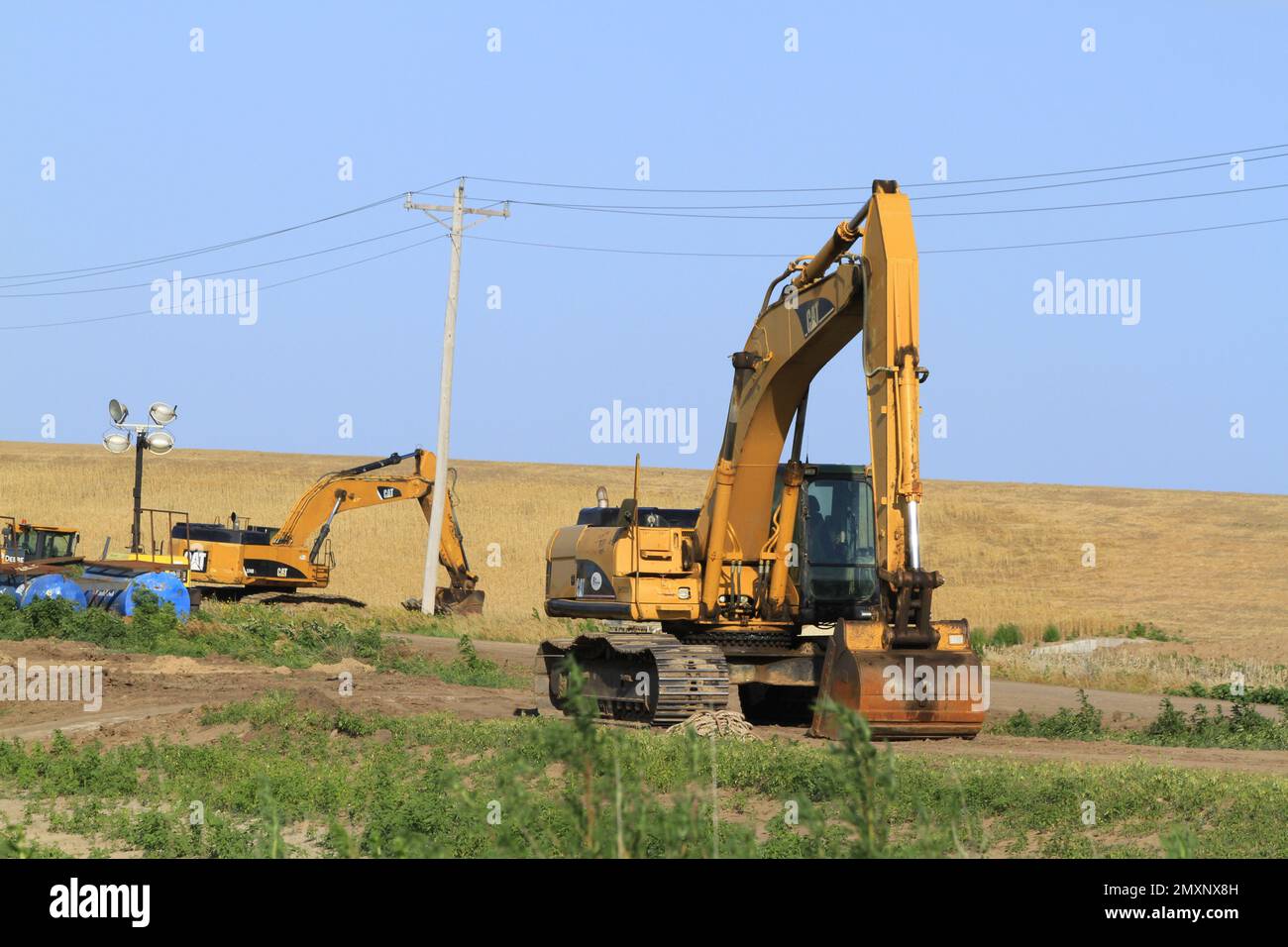 CAT EXCAVATOR at a work site ready for work with blue sky out in the ...