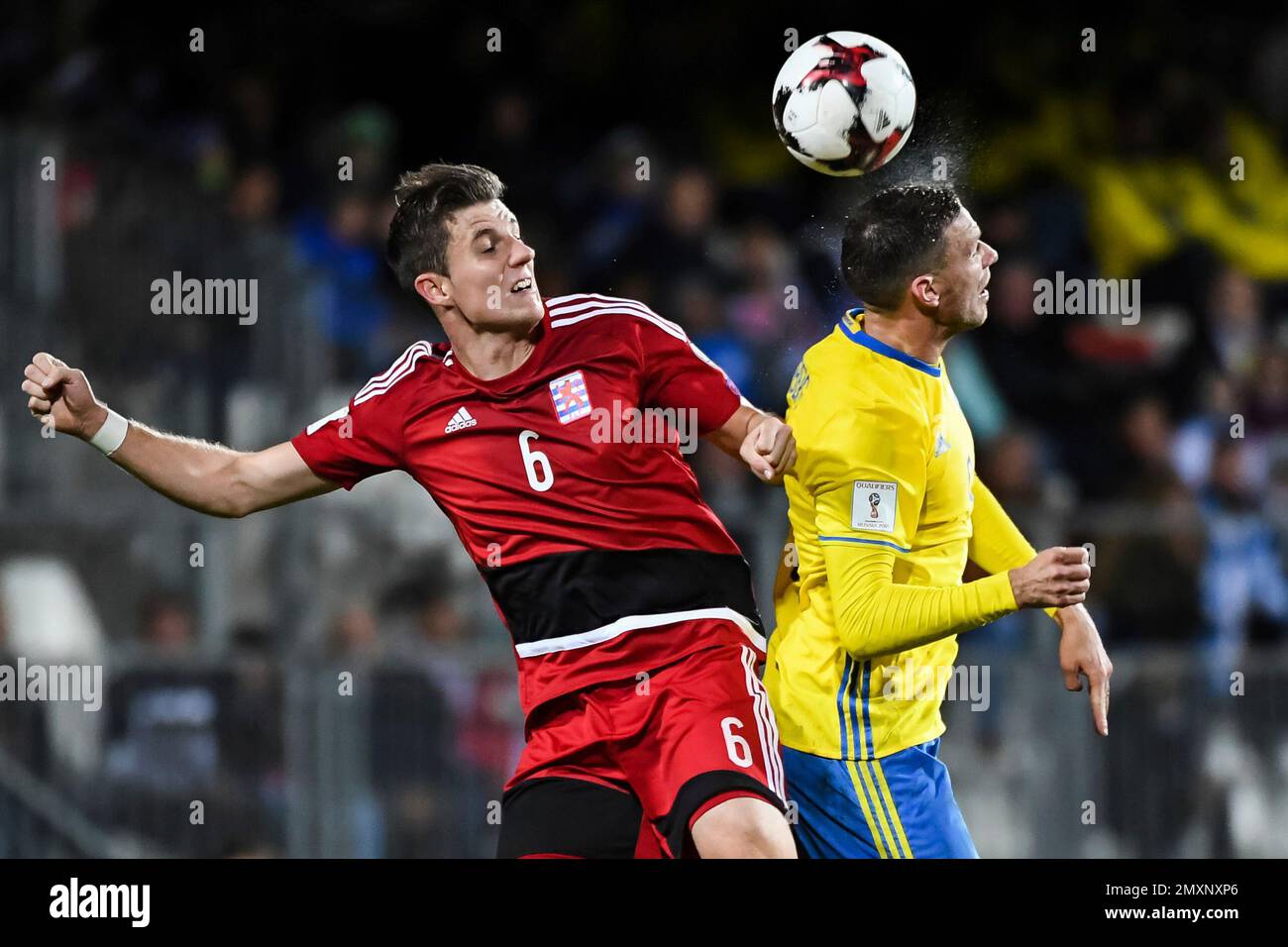 Luxembourg's Chris Philipps, left, challenges Sweden's Marcus Berg ...
