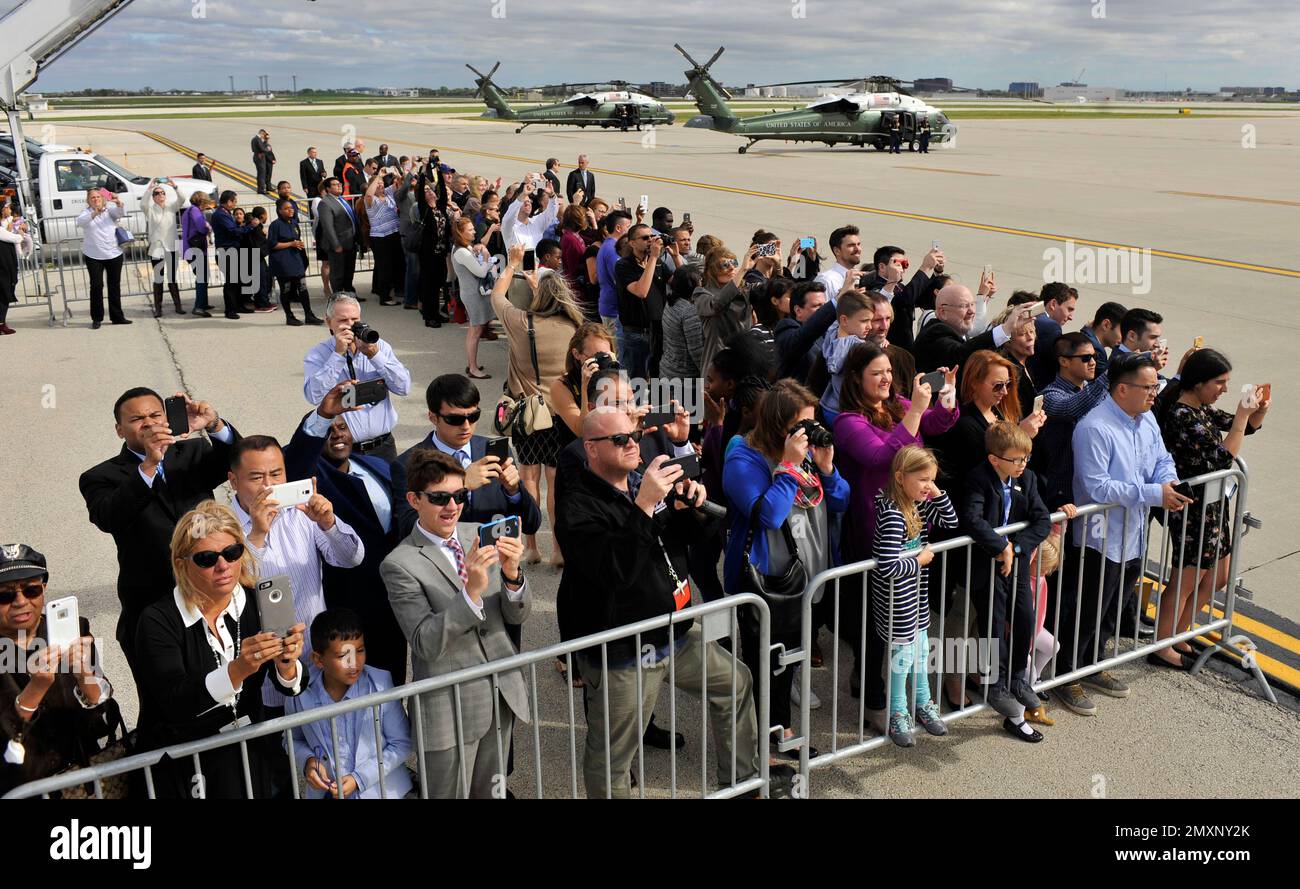 Supporters take photos of Air Force One on the tarmac after landing at ...