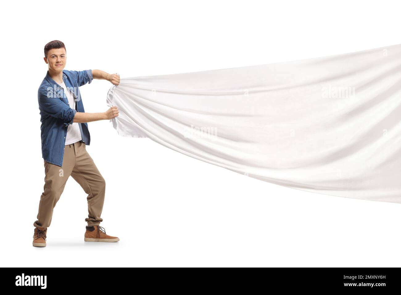 Guy pulling a big white cloth isolated on white background Stock Photo ...