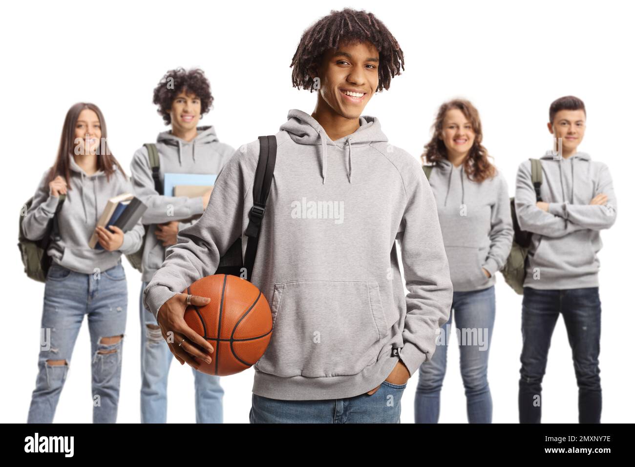 Male african american student holding a basketball and other students ...