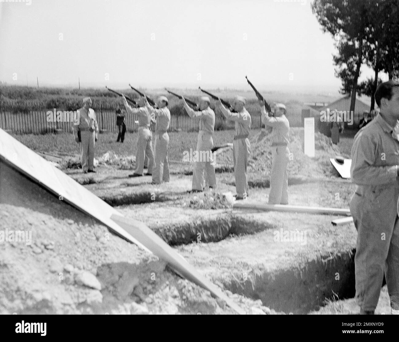 U.S. soldiers fire a three-volley salute at funeral services for eight ...