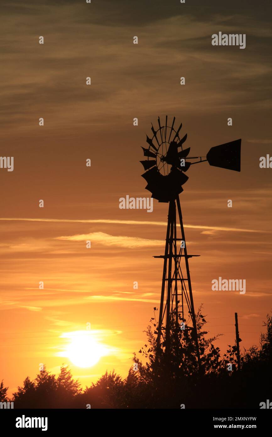 Silhouette of farm windmill at sunset hi-res stock photography and ...