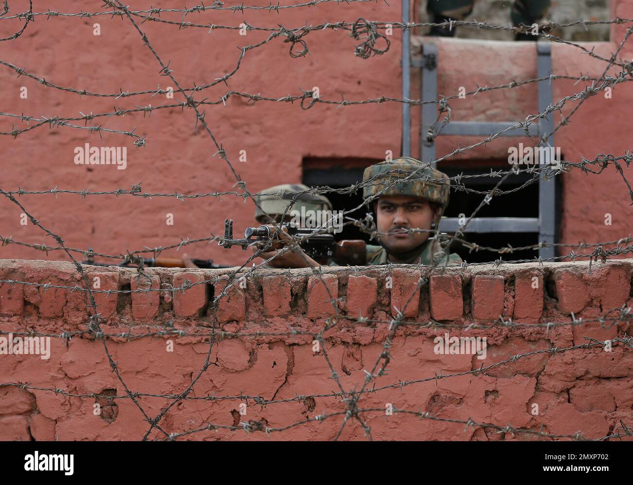 An Indian Army soldier guards his base camp in Langate 75 kilometers ...