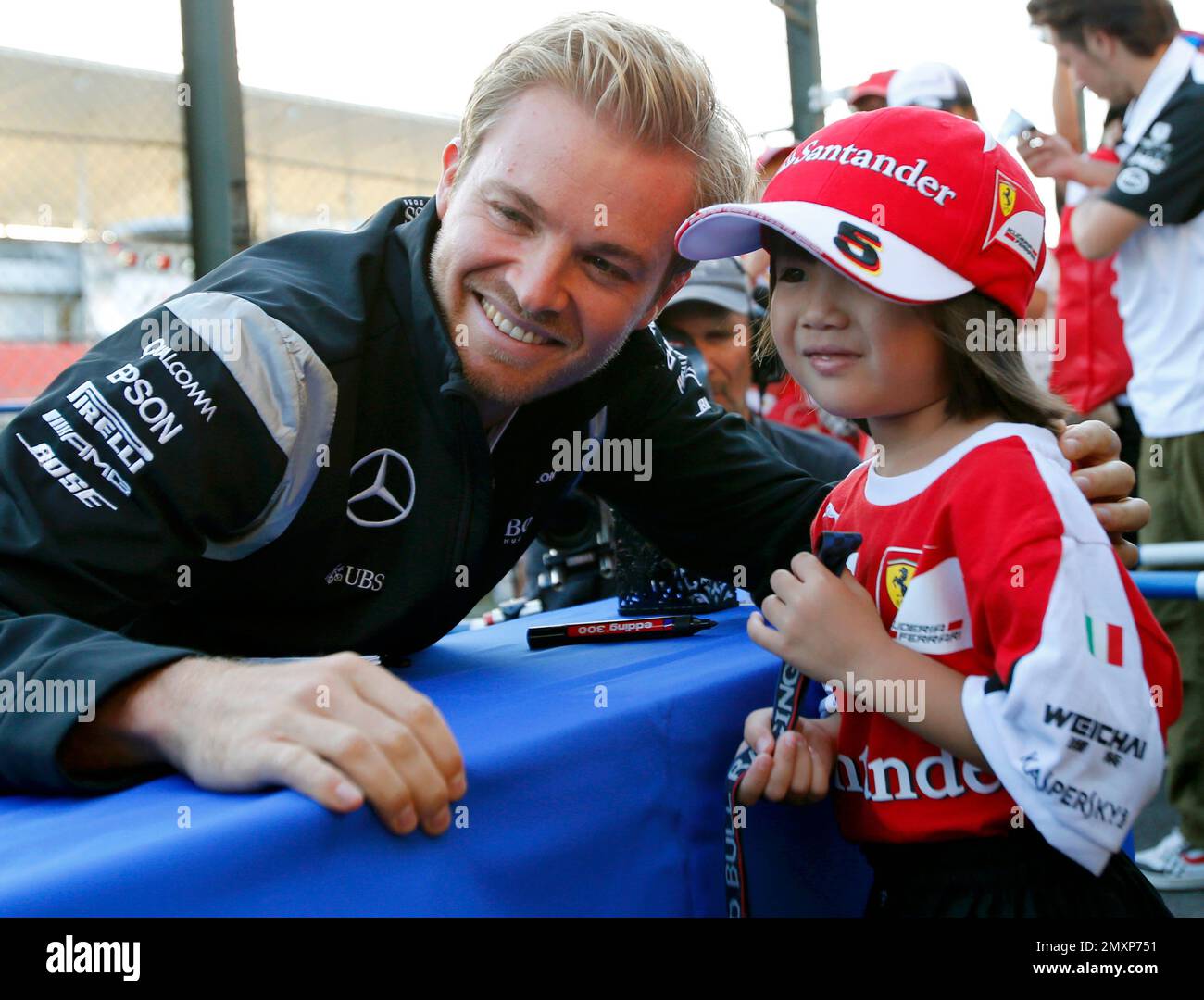 Mercedes driver Nico Rosberg of Germany poses with a Japanese girl ...
