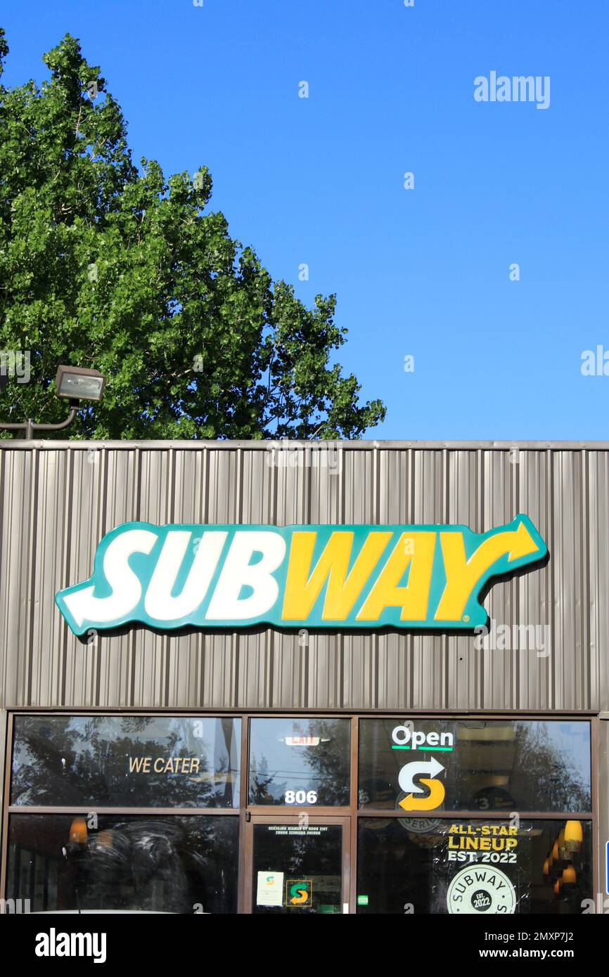 A SUBWAY advertisement sign on a store with blue sky Stock Photo - Alamy