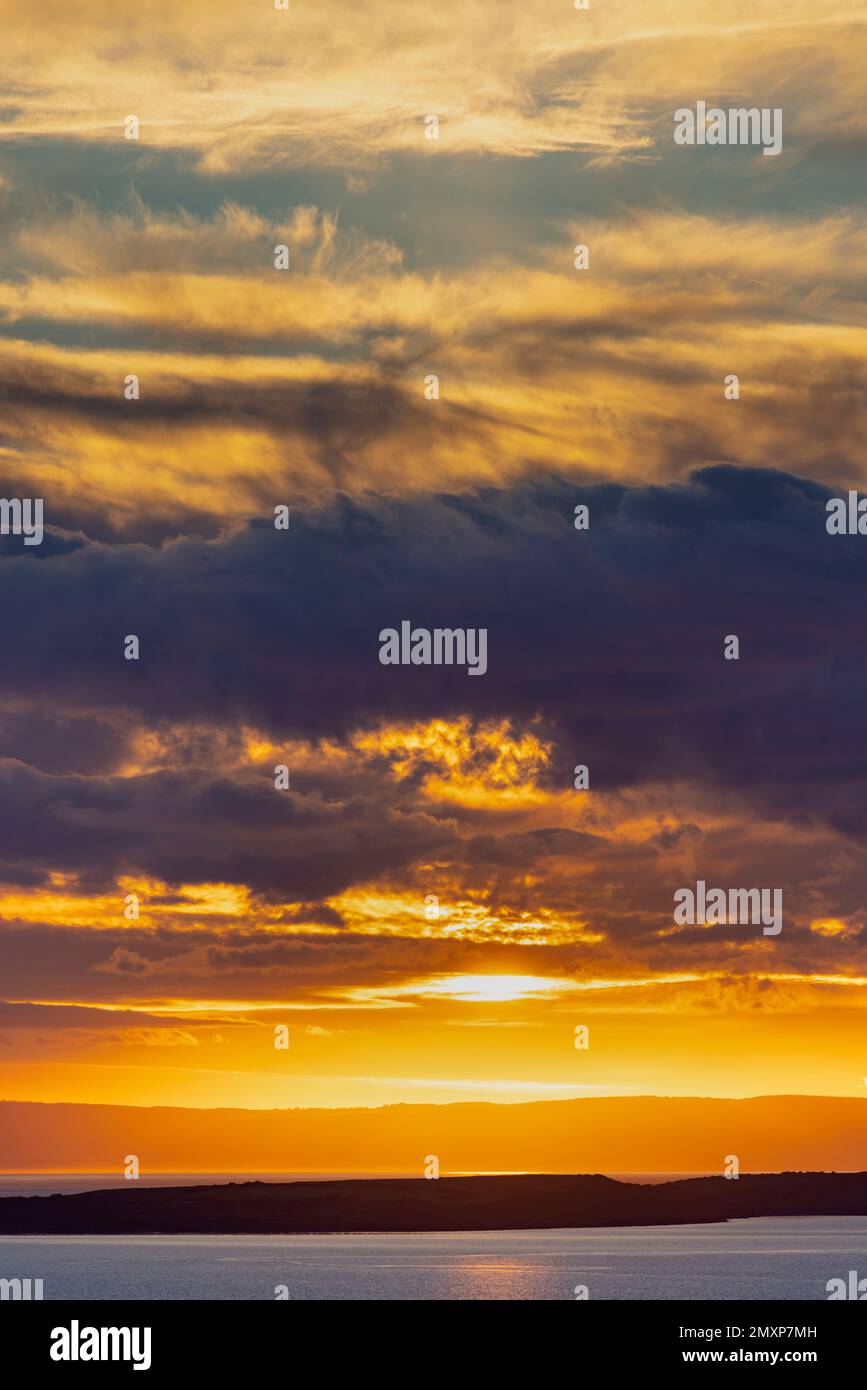 The setting sun lighting up the cloud cover Stock Photo - Alamy