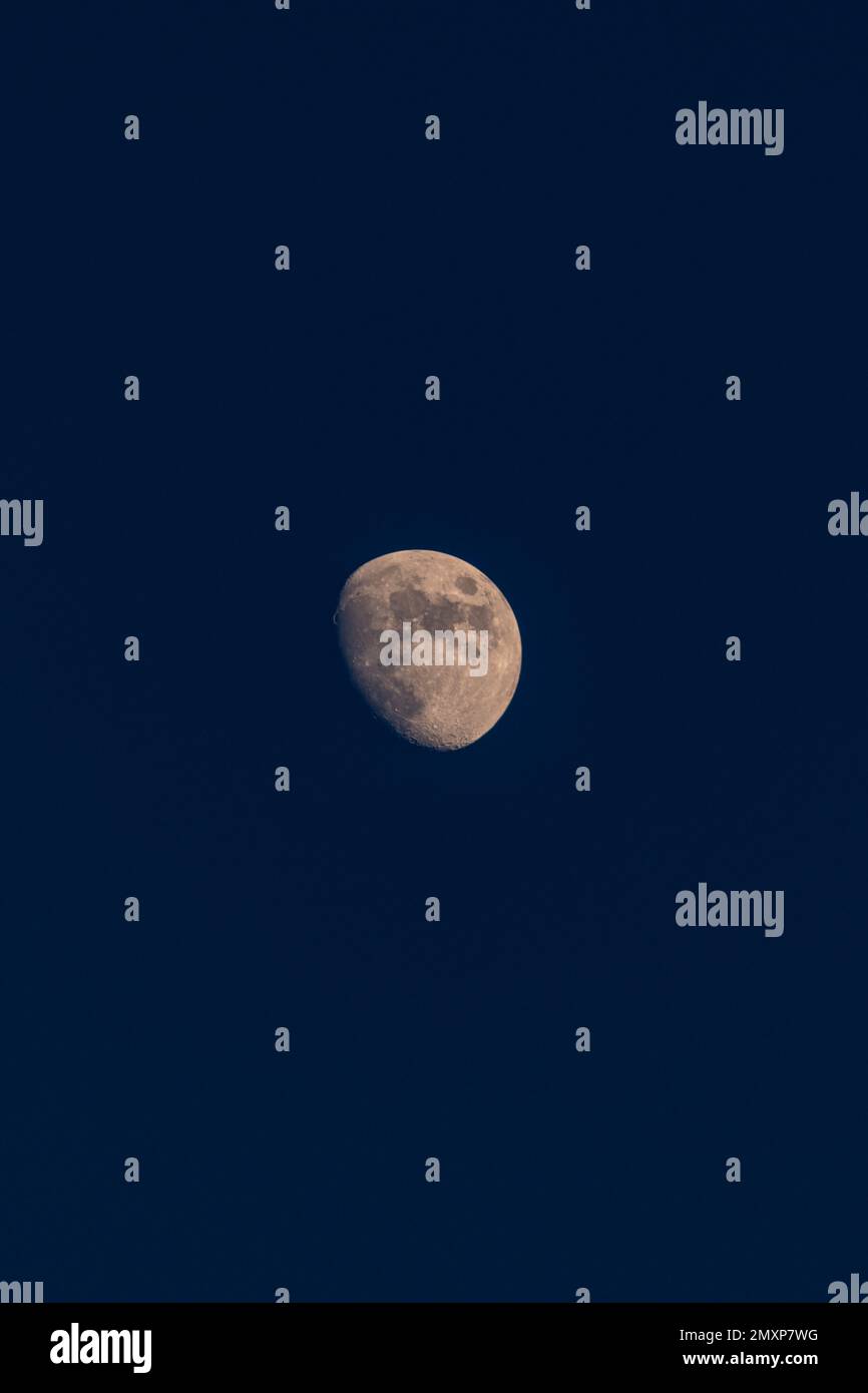 Three-quarter moon against a deep blue sky Stock Photo - Alamy