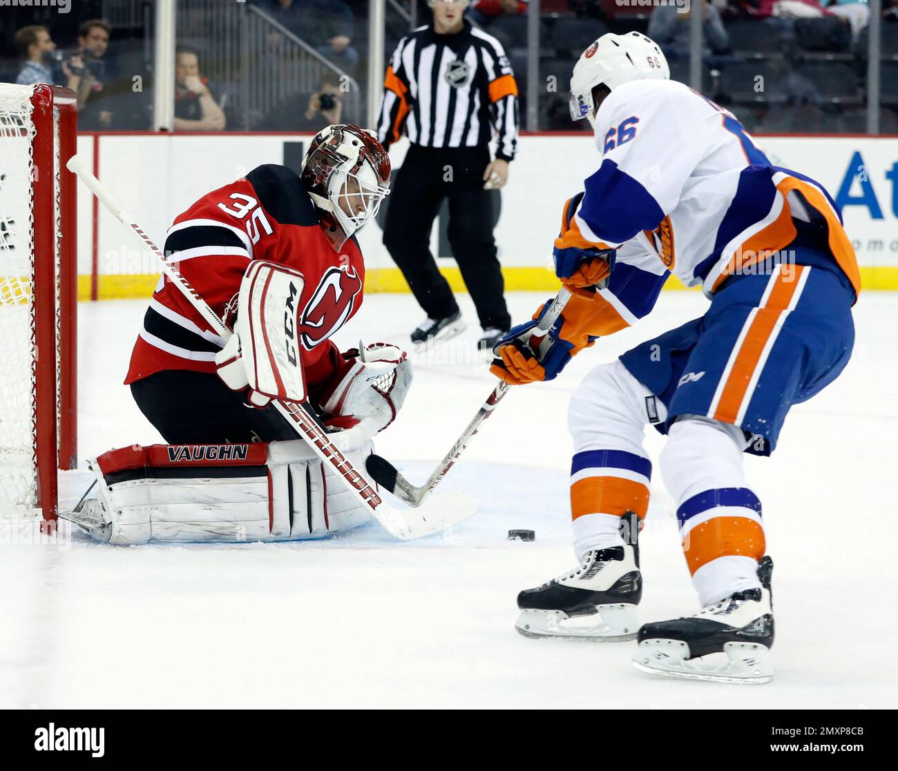 New Jersey Devils goalie Cory Schneider, left, deflects a shot by New ...