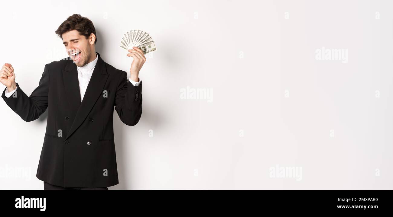 Portrait of handsome and successful businessman in suit, dancing with ...