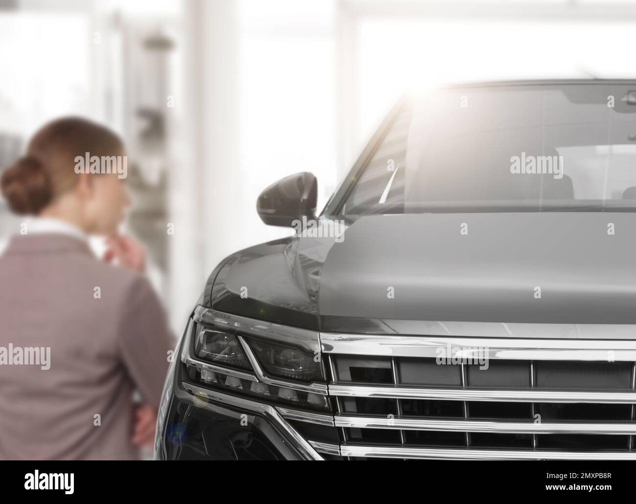 Customer choosing and buying car in auto dealership, focus on new auto ...