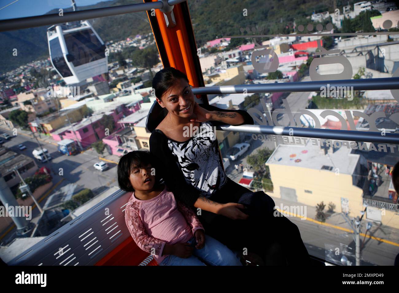 Residents ride over neighborhoods as they try out a new gondola ...