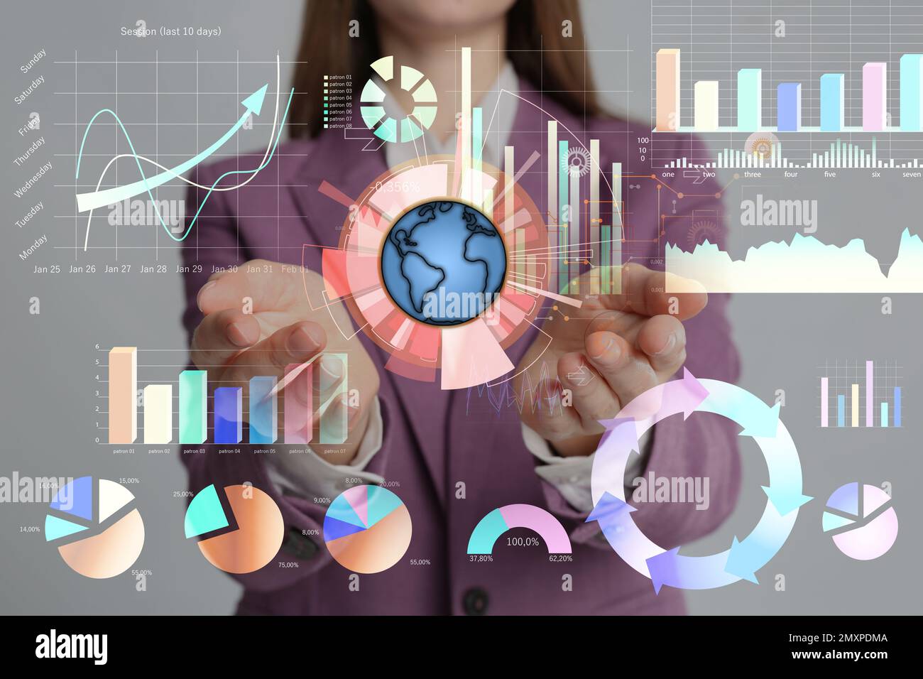 Young woman demonstrating world globe and digital graphics on grey ...