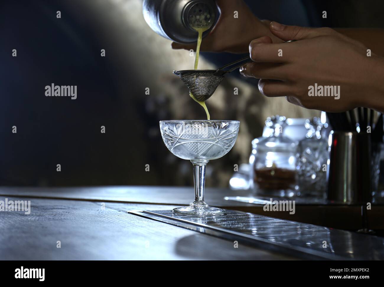 Bartender preparing fresh alcoholic cocktail at bar counter, closeup ...