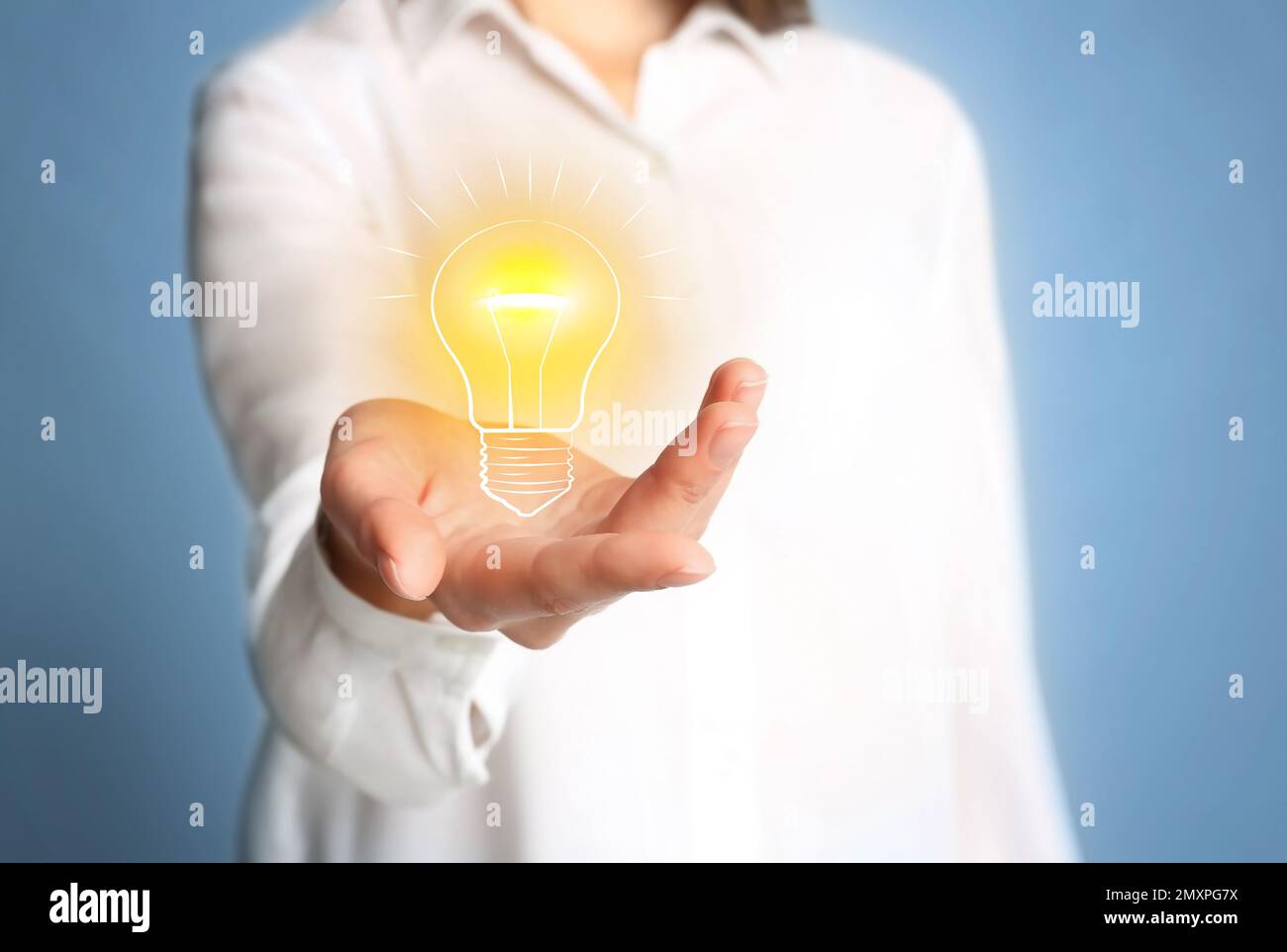 Idea concept. Businesswoman demonstrating glowing light bulb ...