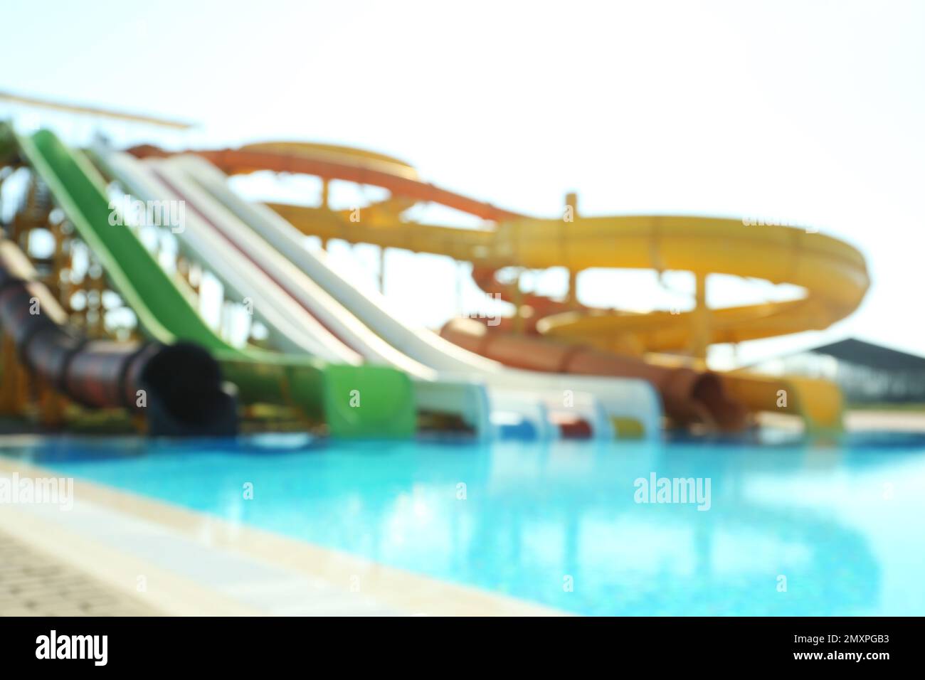 Different colorful slides in water park, blurred view Stock Photo - Alamy