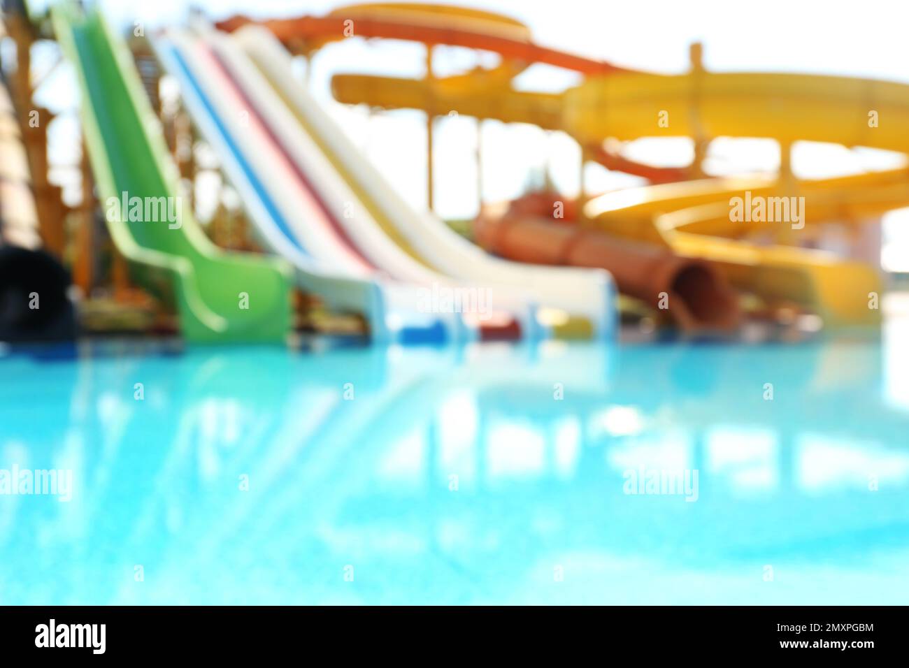 Different colorful slides in water park, blurred view Stock Photo - Alamy