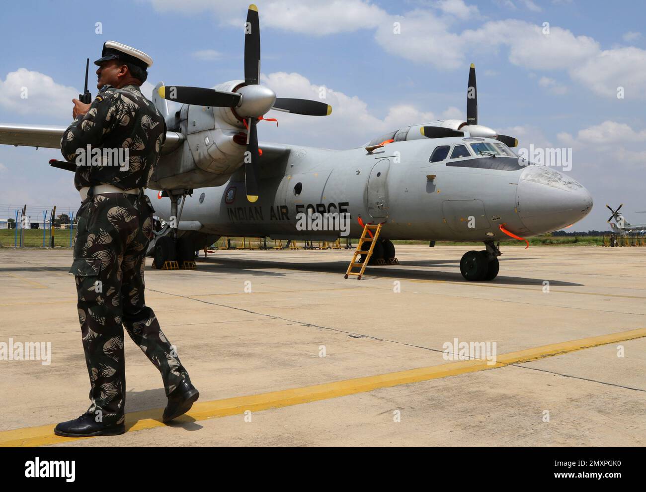 An Indian Air Force (IAF) official talks on his radio transmitter next ...
