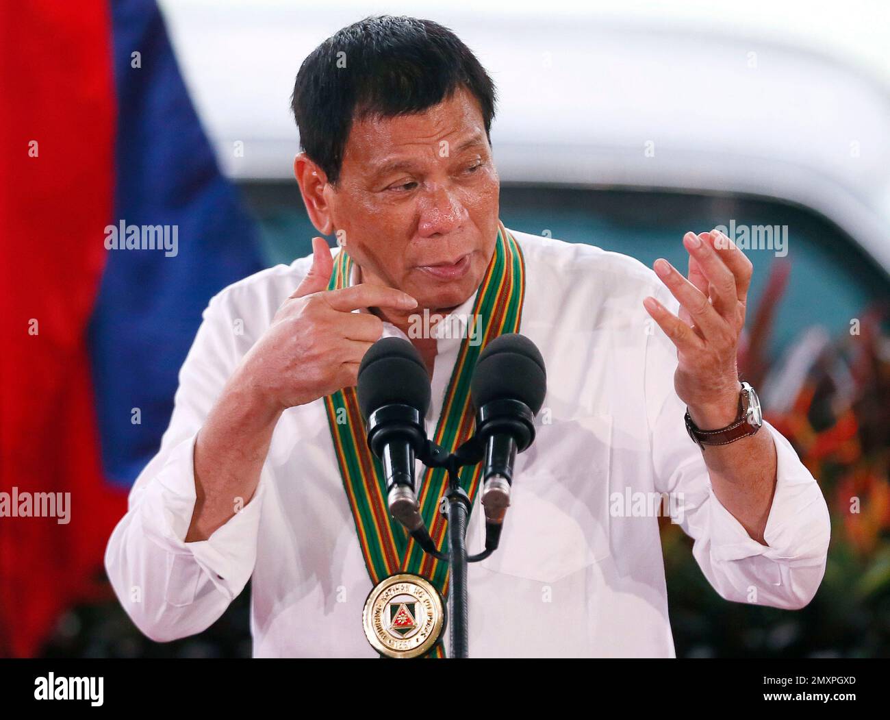 Philippine President Rodrigo Duterte gestures with a firing stance as ...