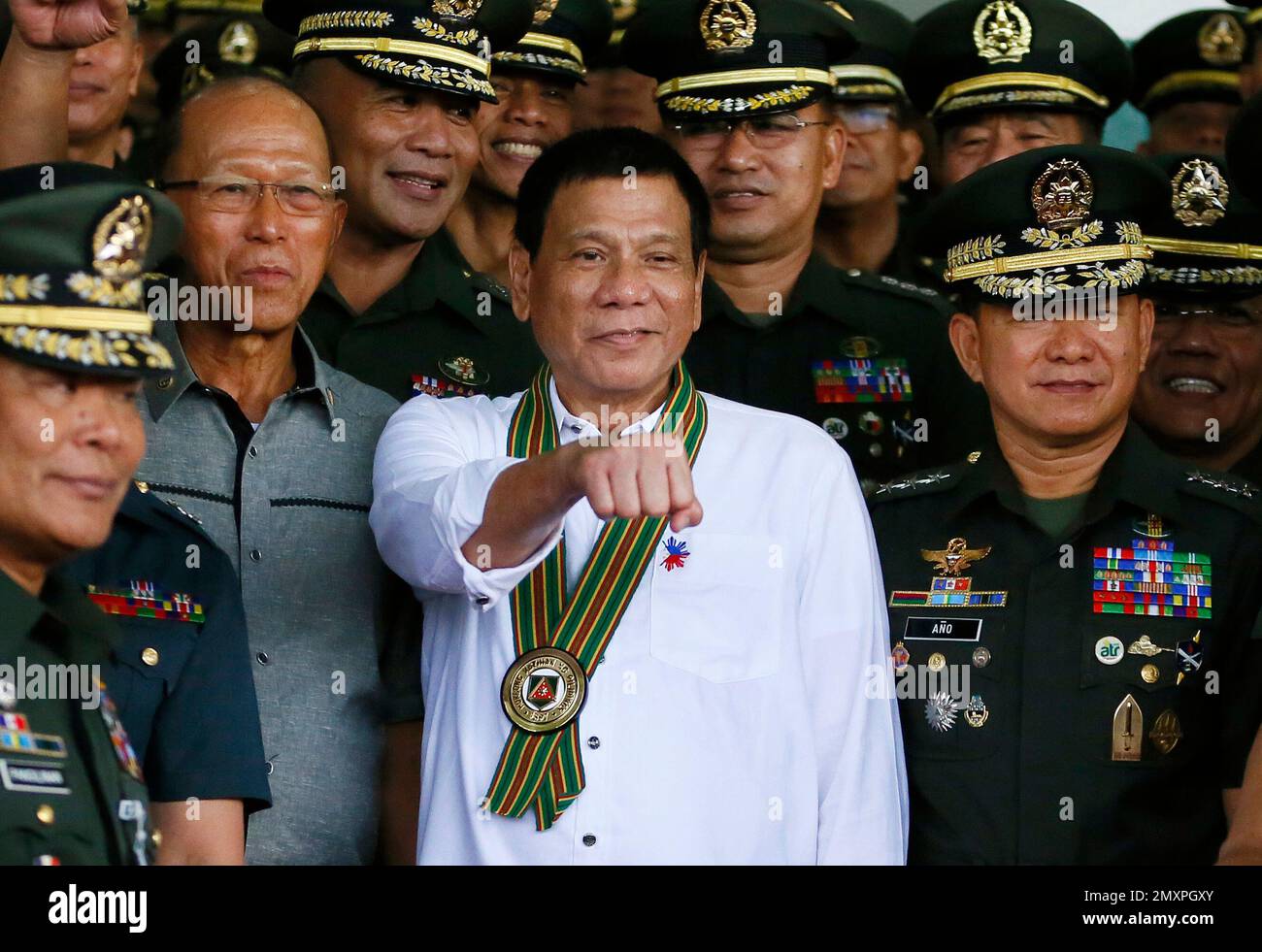 Philippine President Rodrigo Duterte, center, gestures with a fist bump ...