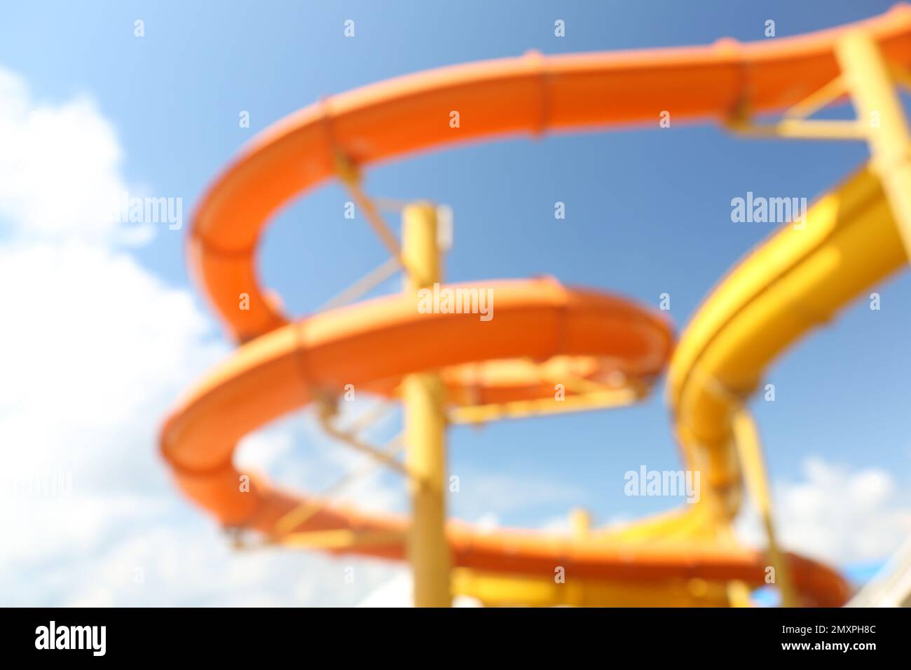 Different colorful slides in water park, blurred view Stock Photo - Alamy