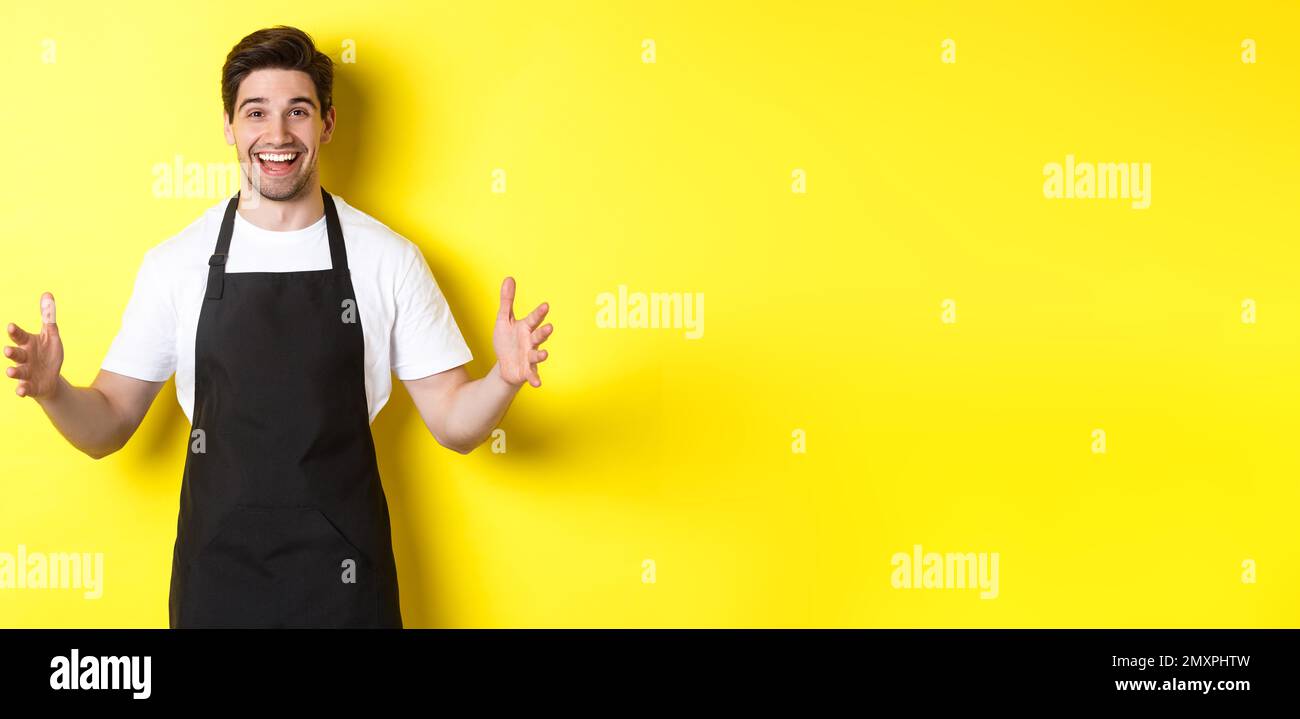Happy barista holding something big, shaping large object, standing ...