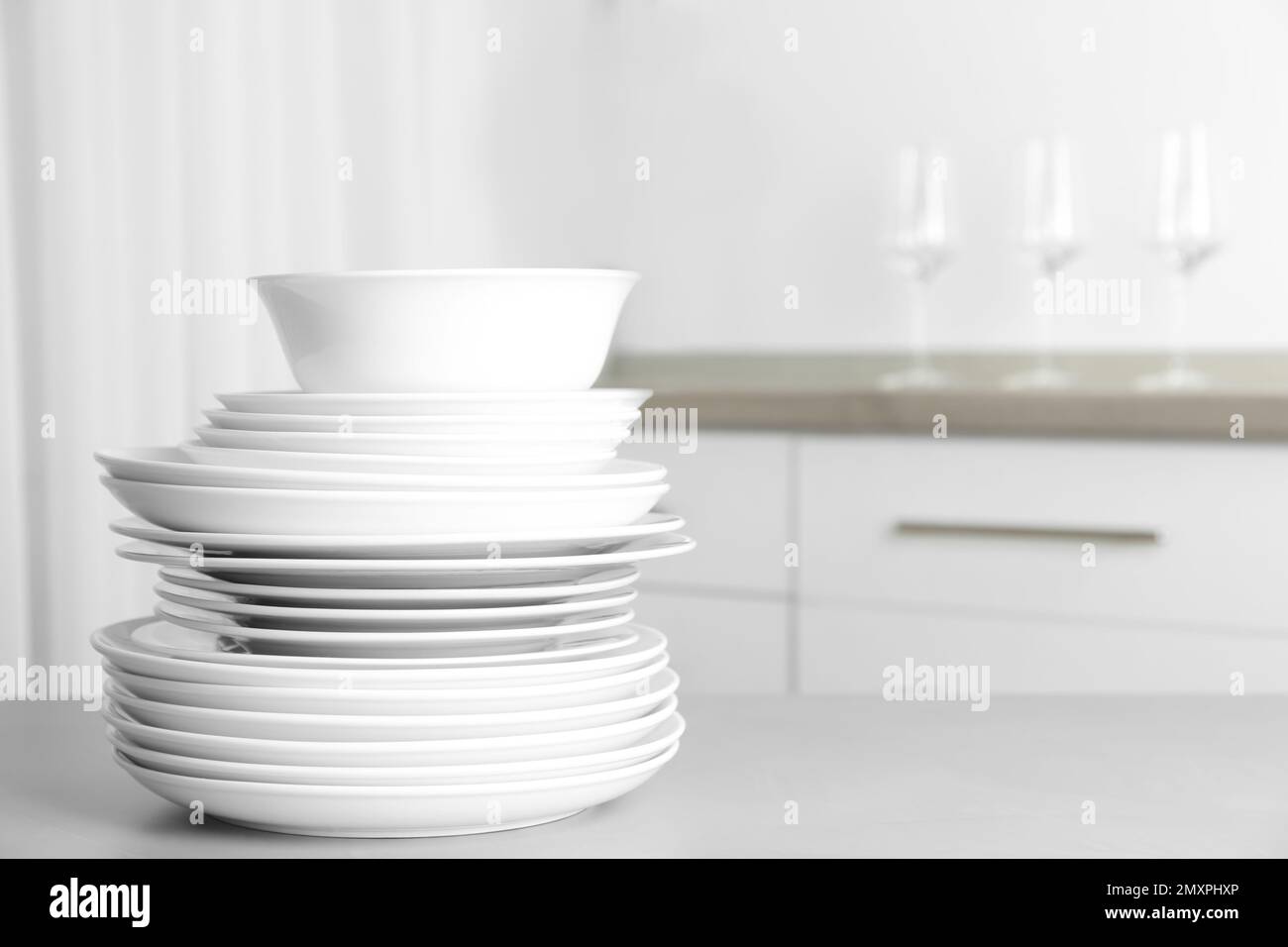 Stack of clean plates on grey table in kitchen. Space for text Stock ...