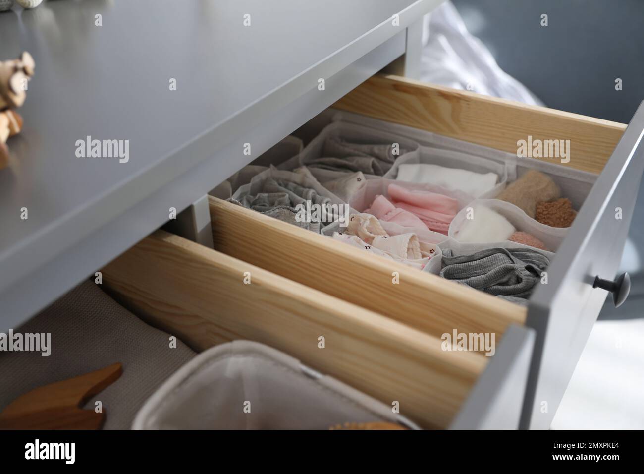 Open cabinet drawer with clothes in child room Stock Photo - Alamy