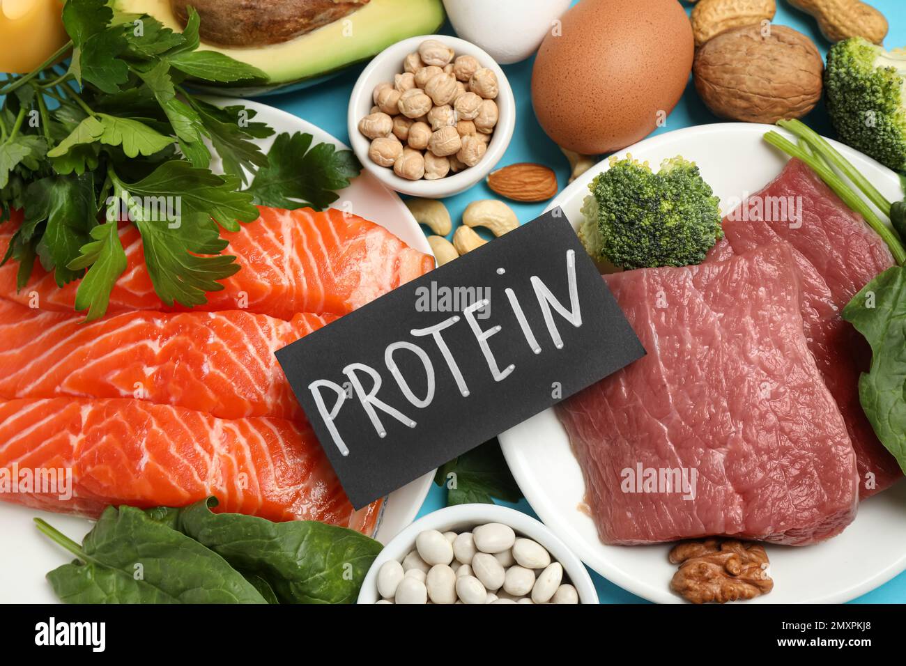 Card with word PROTEIN and different products on light blue background ...