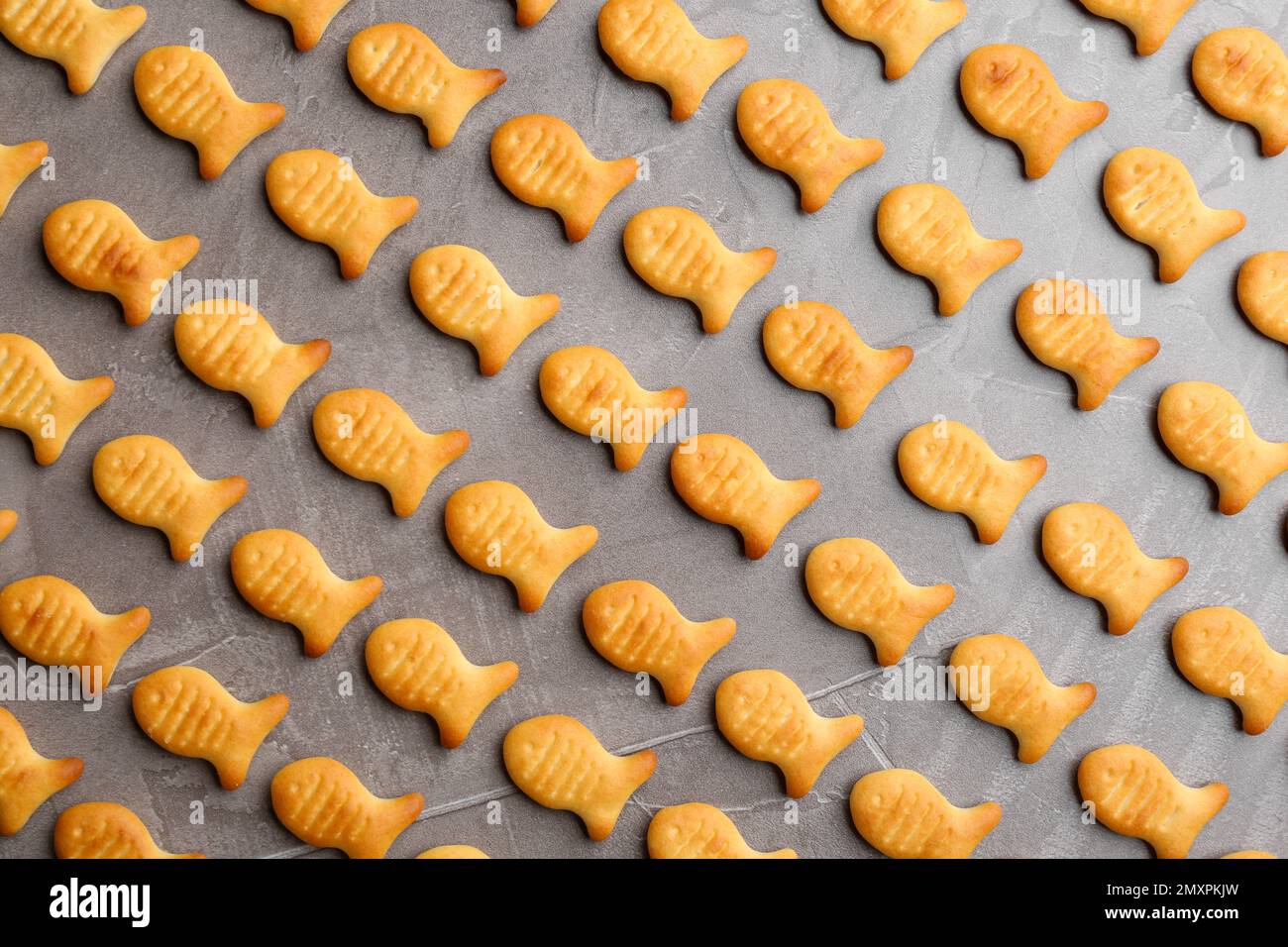 Delicious goldfish crackers on grey table, flat lay Stock Photo - Alamy