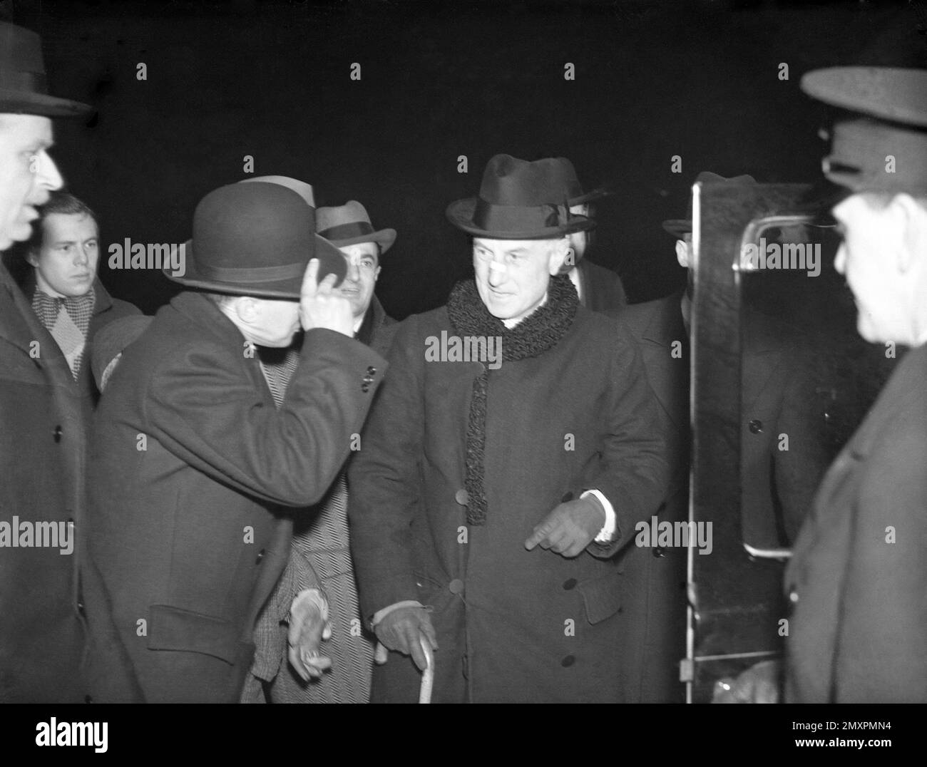 Sir Samuel Hoare, wearing a strip of plaster over his broken nose ...