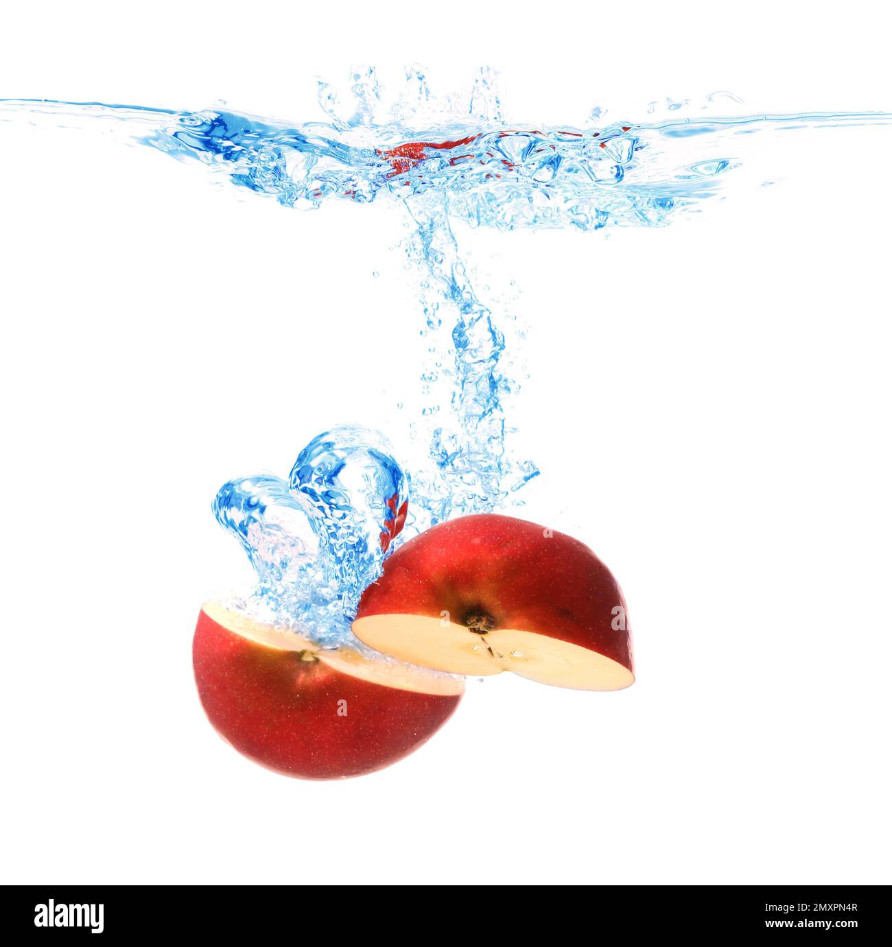 Cut apple falling down into clear water against white background Stock ...