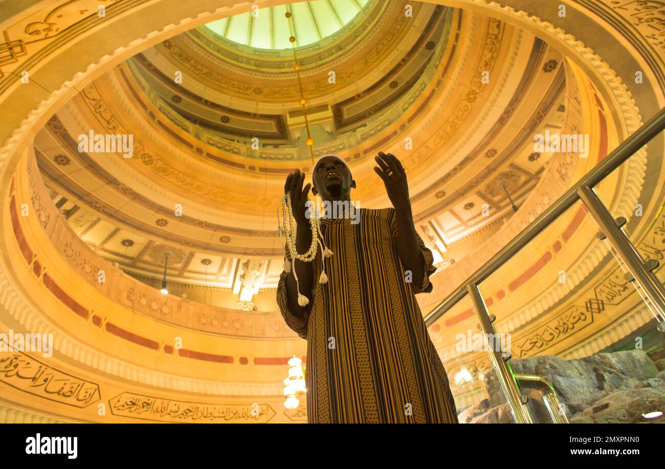 A Nigerian pilgrim prays near Al-Safa mountain, at right, at the Grand ...