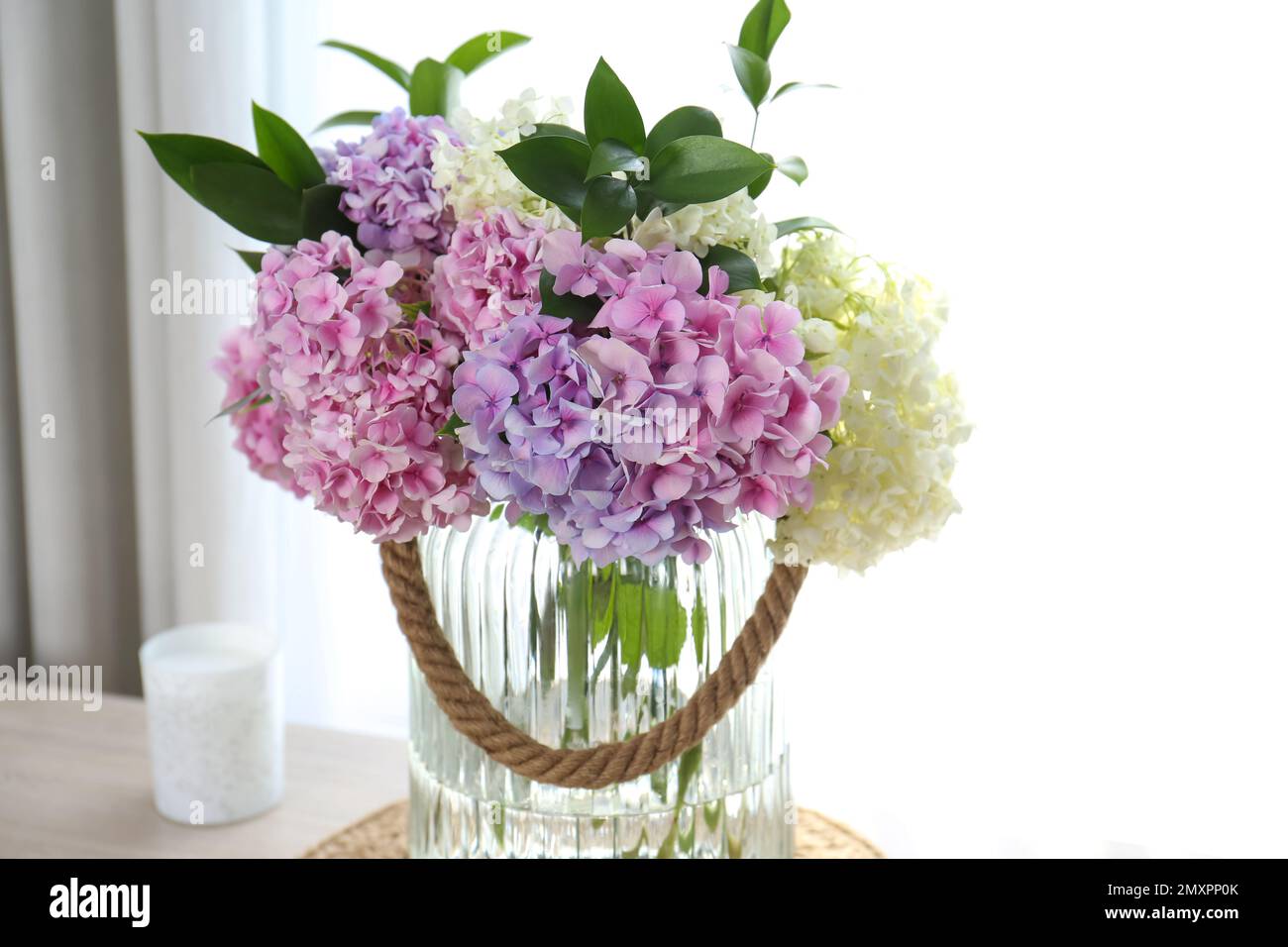 Bouquet of beautiful hydrangea flowers on table near window. Interior ...