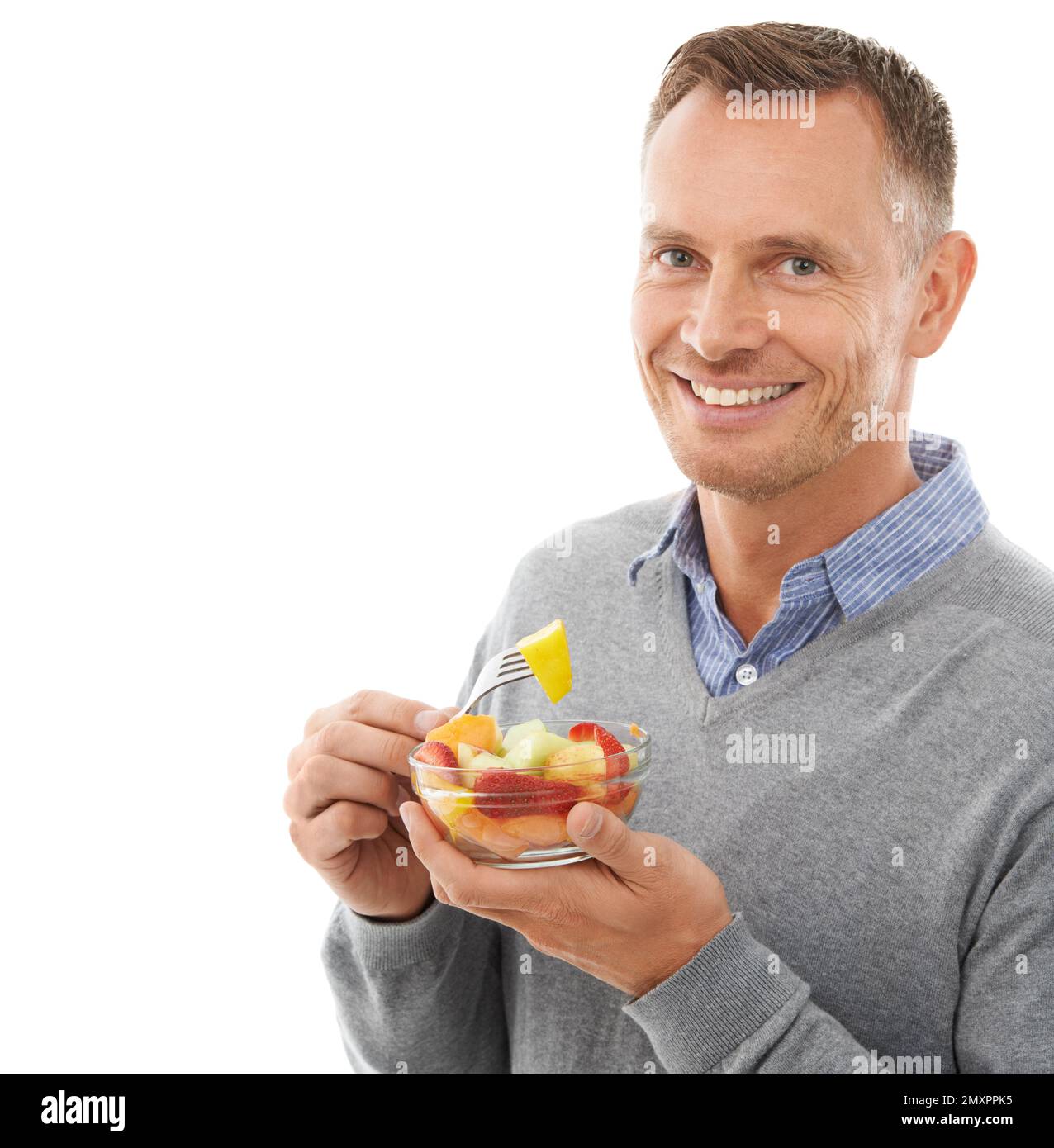 Portrait, studio and happy man eating fruit salad for healthy snack ...