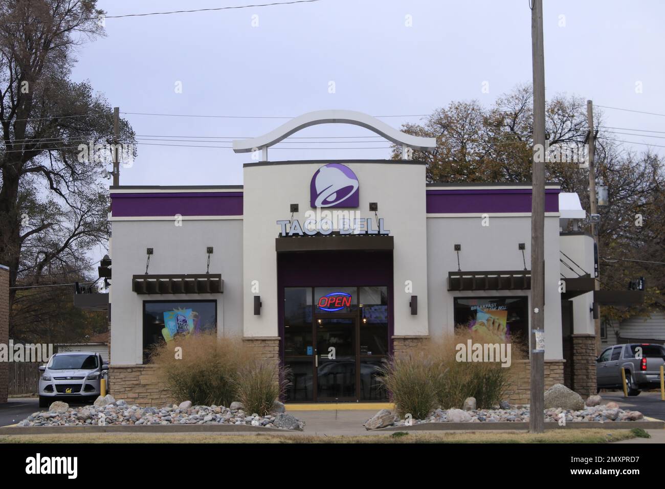 A Taco Bell fast food restaurant store front with trees and blue sky ...