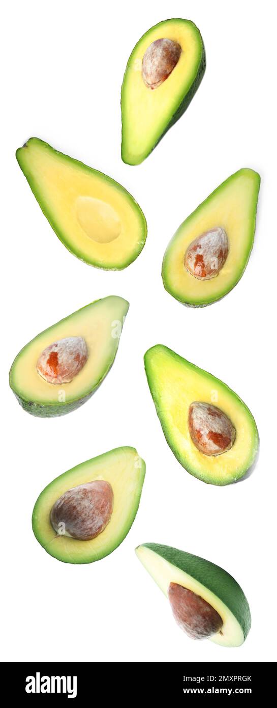 Fresh ripe avocados falling on white background Stock Photo - Alamy