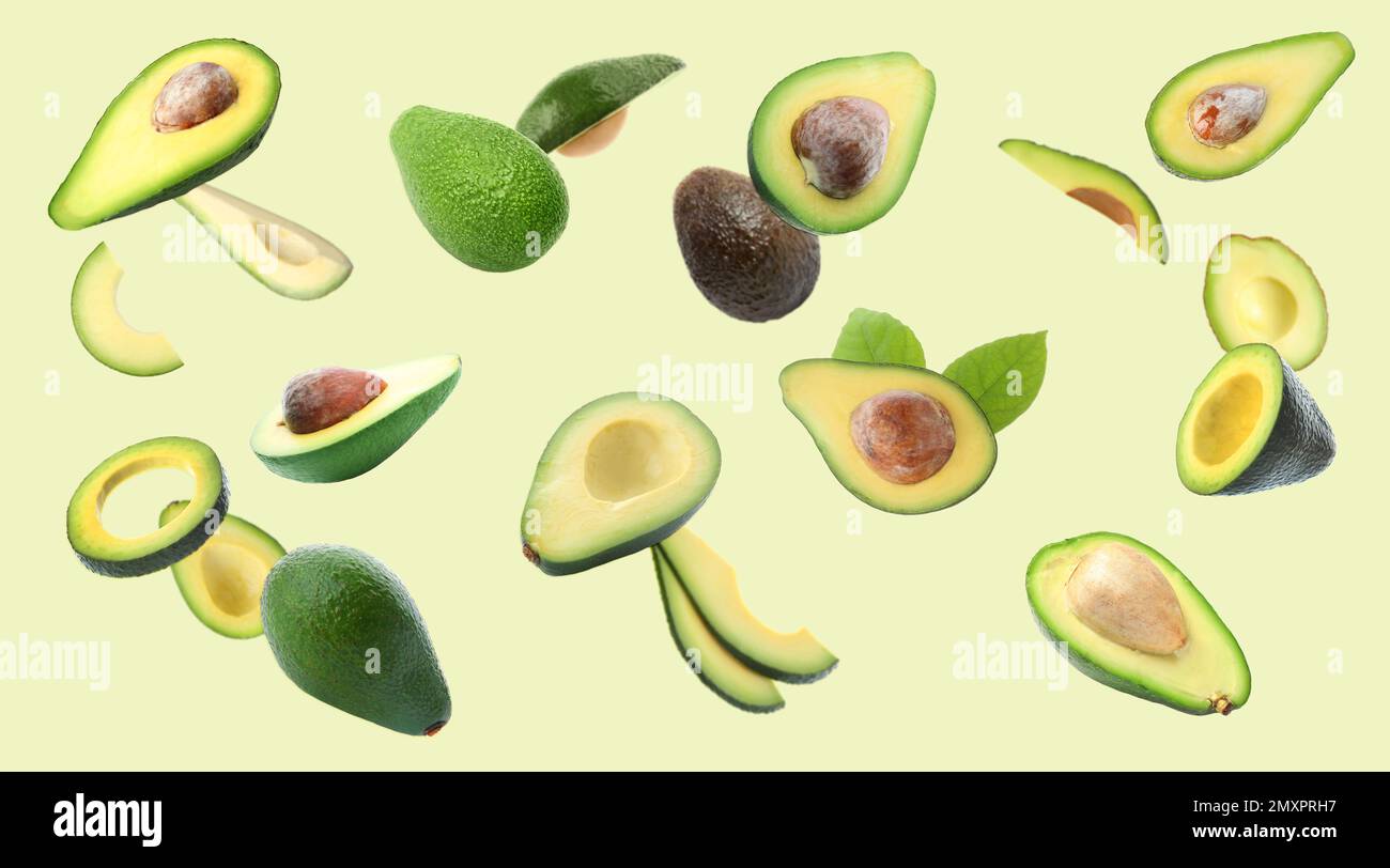 Fresh ripe avocados falling on light background, banner design Stock ...