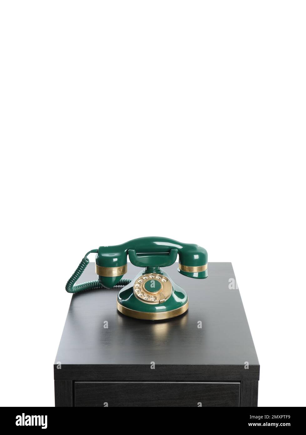 Green vintage corded phone on small black table against white ...