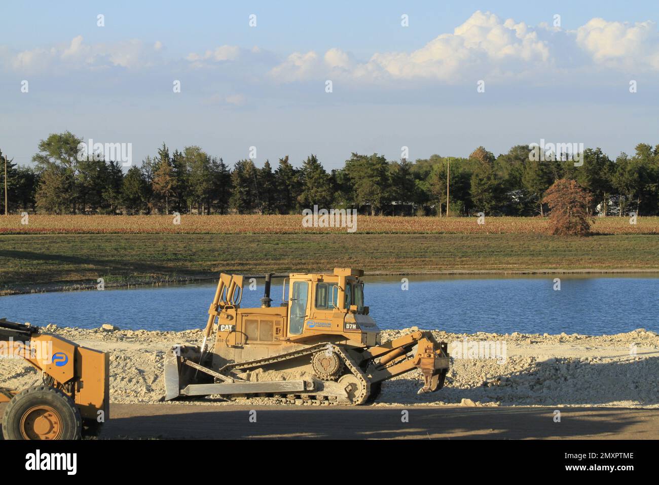 A caterpillar Bull Dozer at a work site with blue sky Stock Photo - Alamy