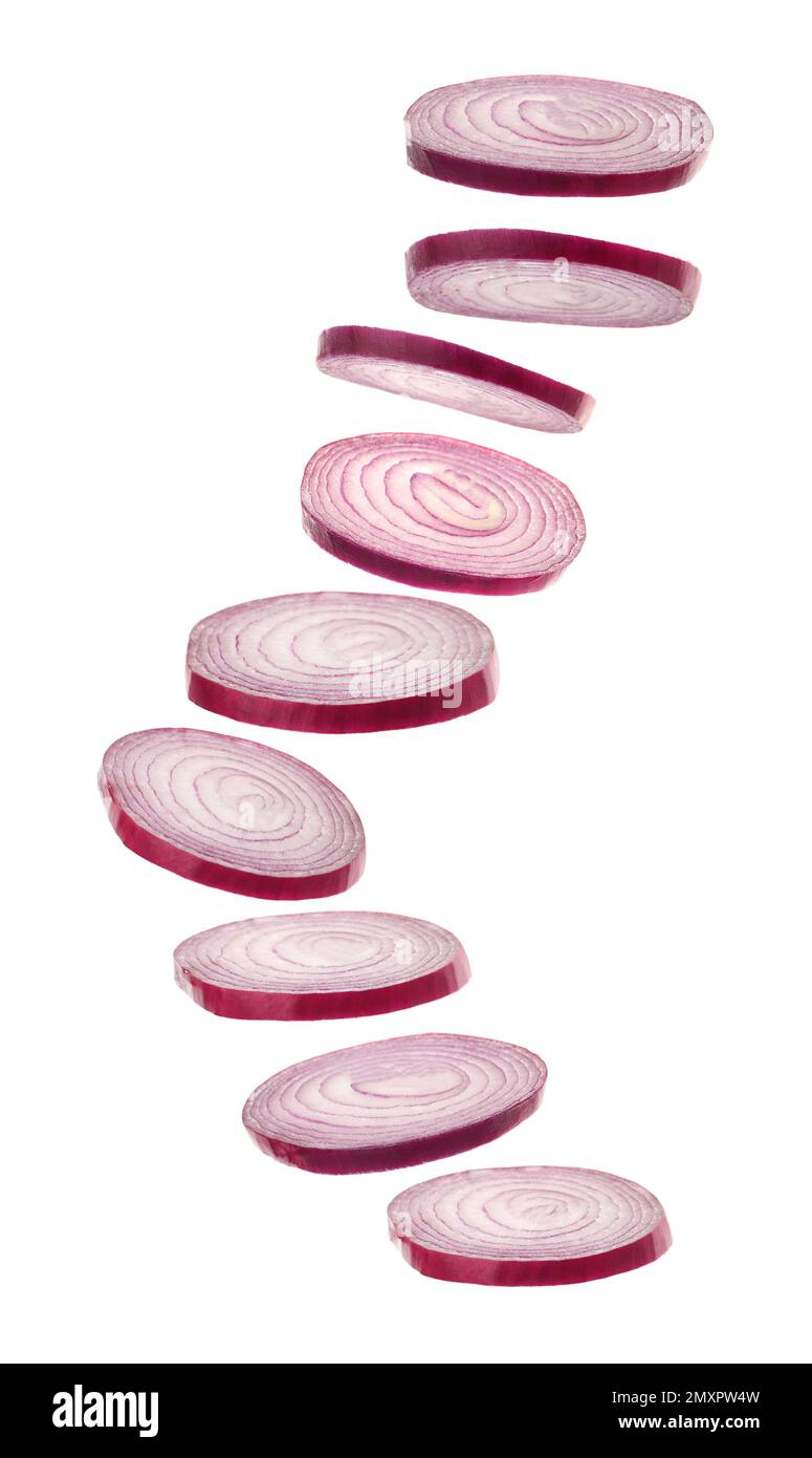 Red onion slices falling on white background Stock Photo - Alamy
