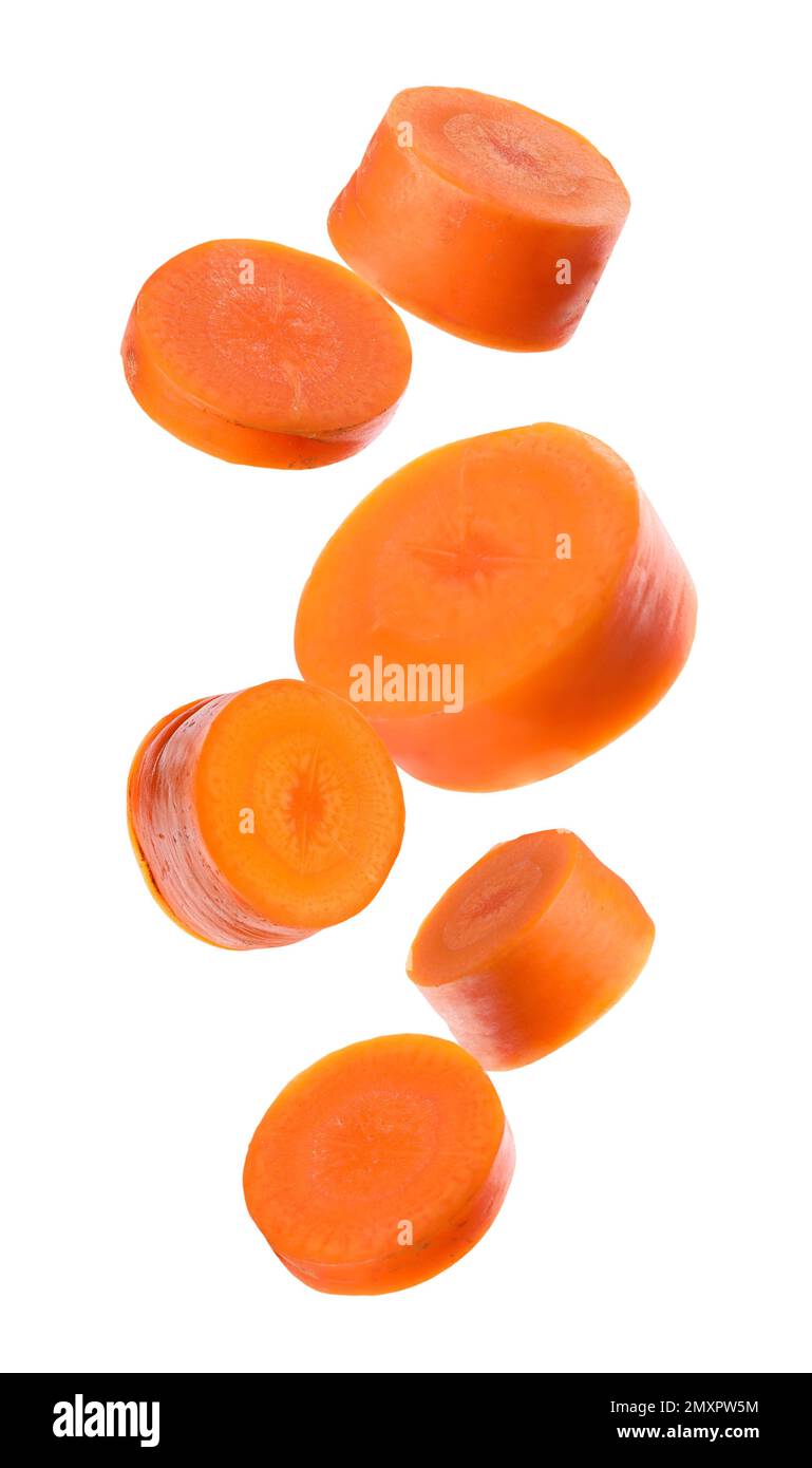 Fresh carrot slices falling on white background Stock Photo - Alamy