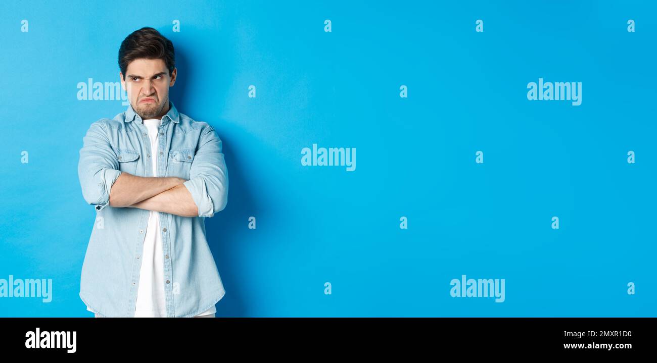 Angry guy cross arms on chest and looking away with insulted expression ...