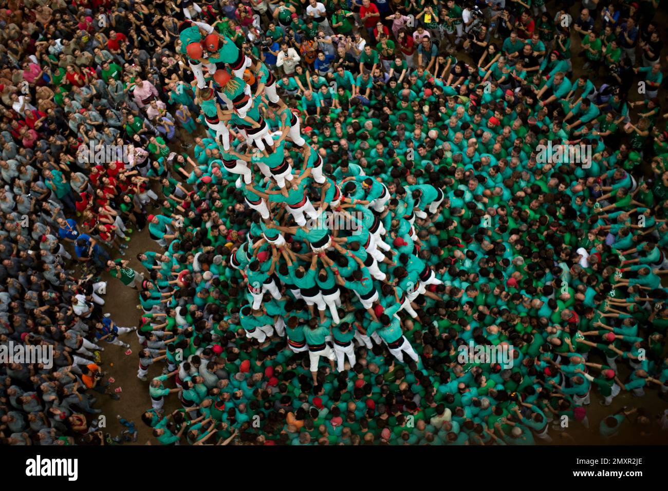 Members of the "Castellers de Villafranca" try to complete their human ...