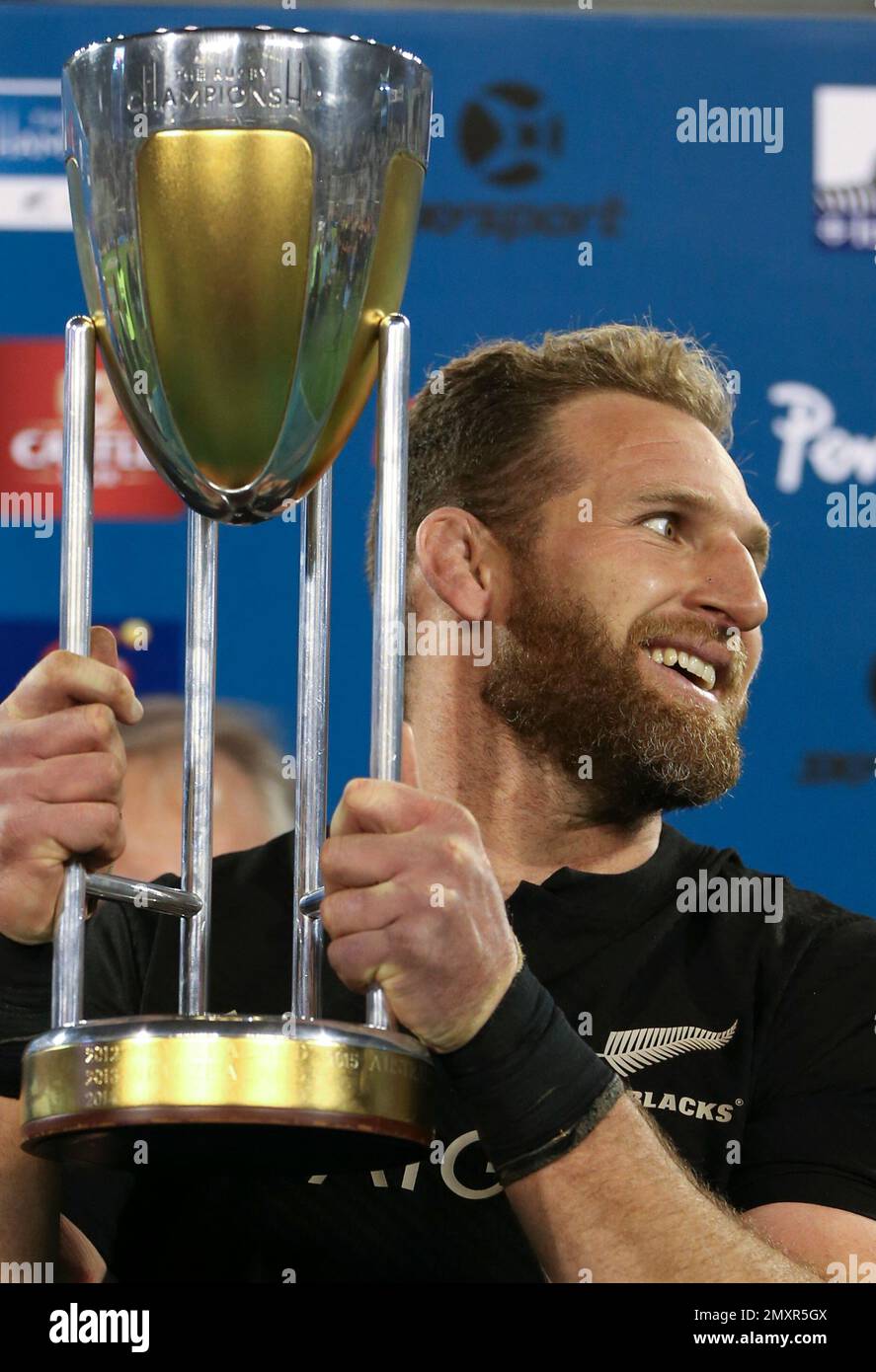 Kieran Read, captain of New Zealand's All Blacks holds up the trophy ...